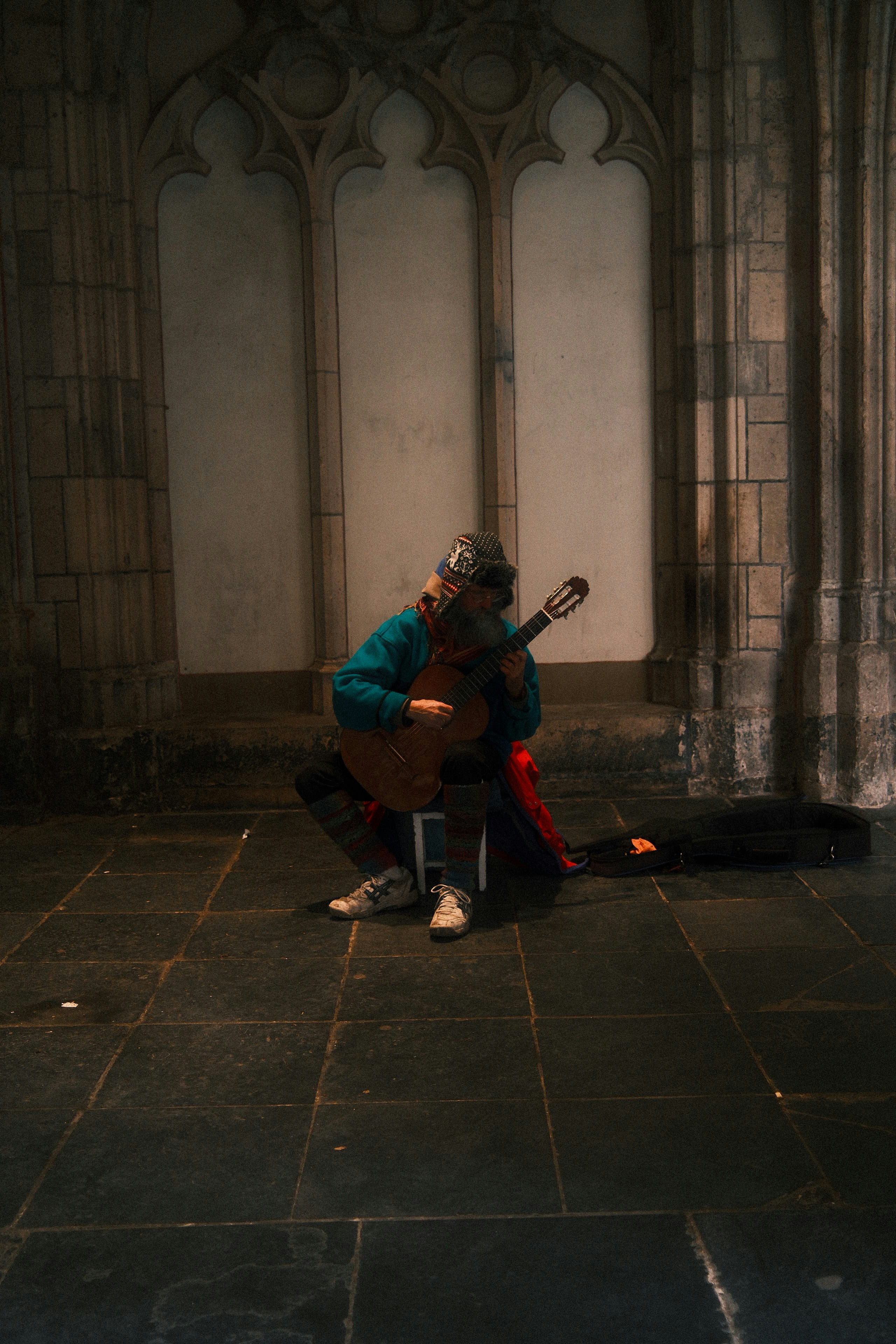 Guitarist in the Cloister: Quiet Melodies Amid Gothic Arches