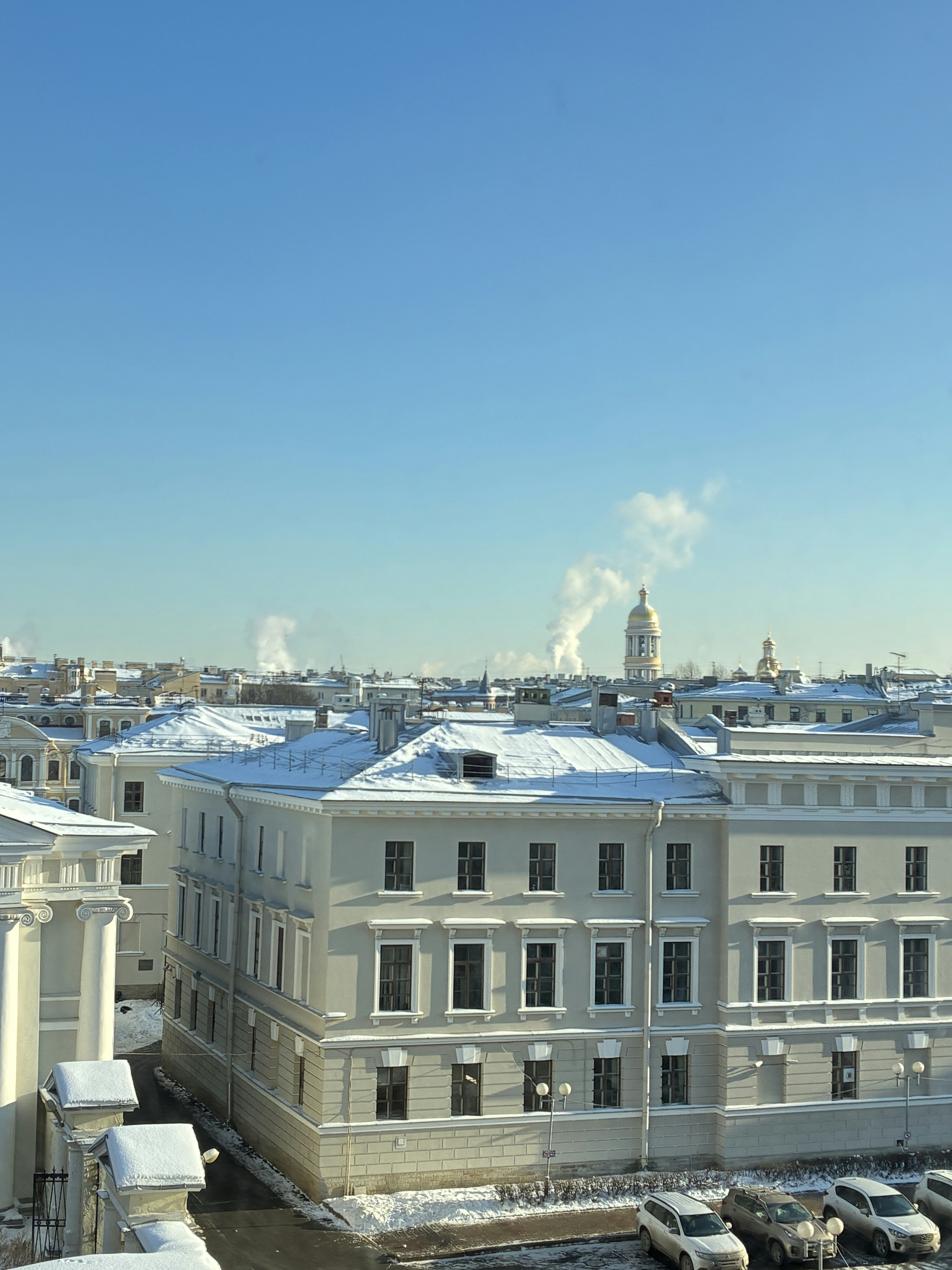 Snow-covered buildings under a clear blue sky