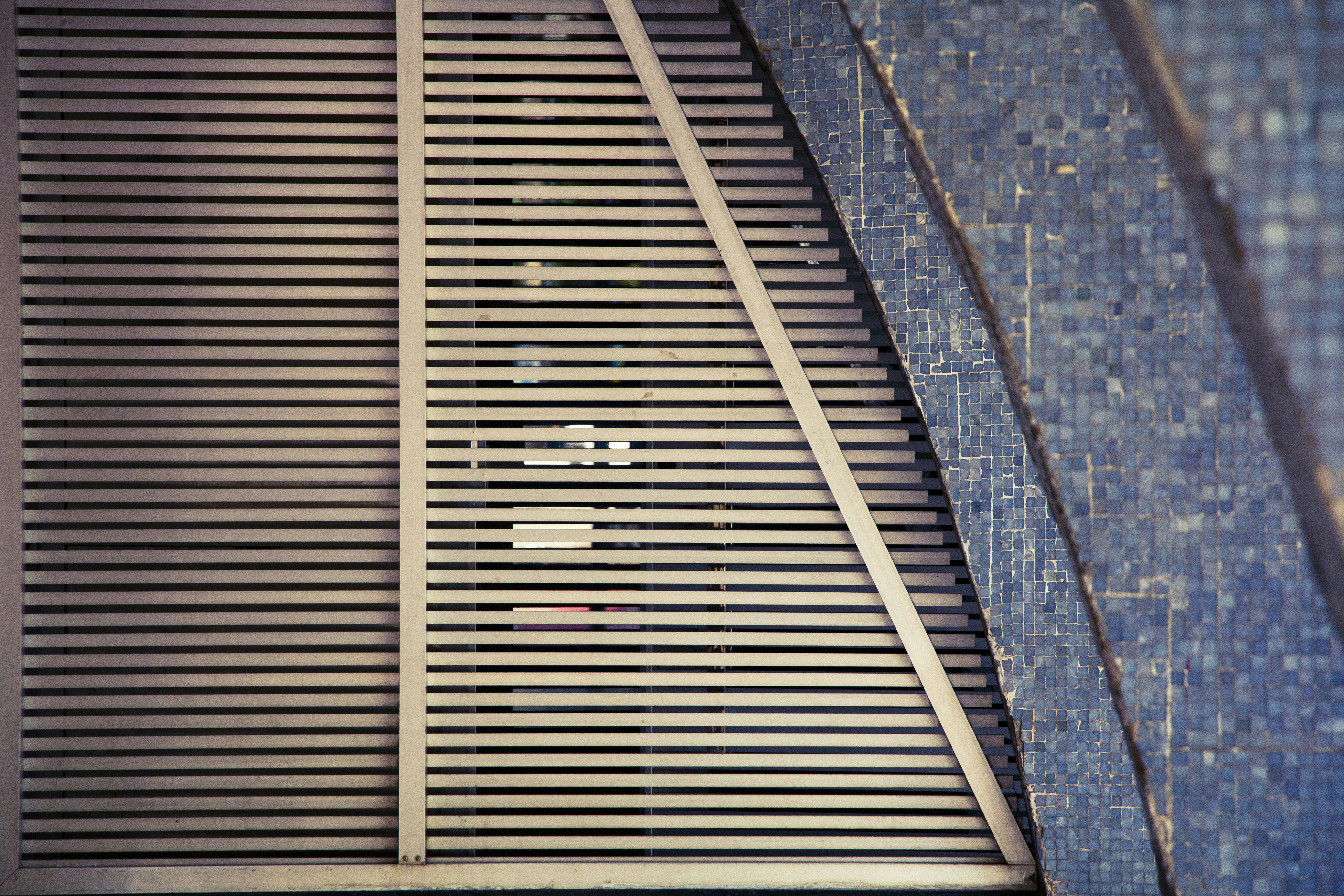 Diagonal Gate: Striated Steel and Mosaic Blue Geometry