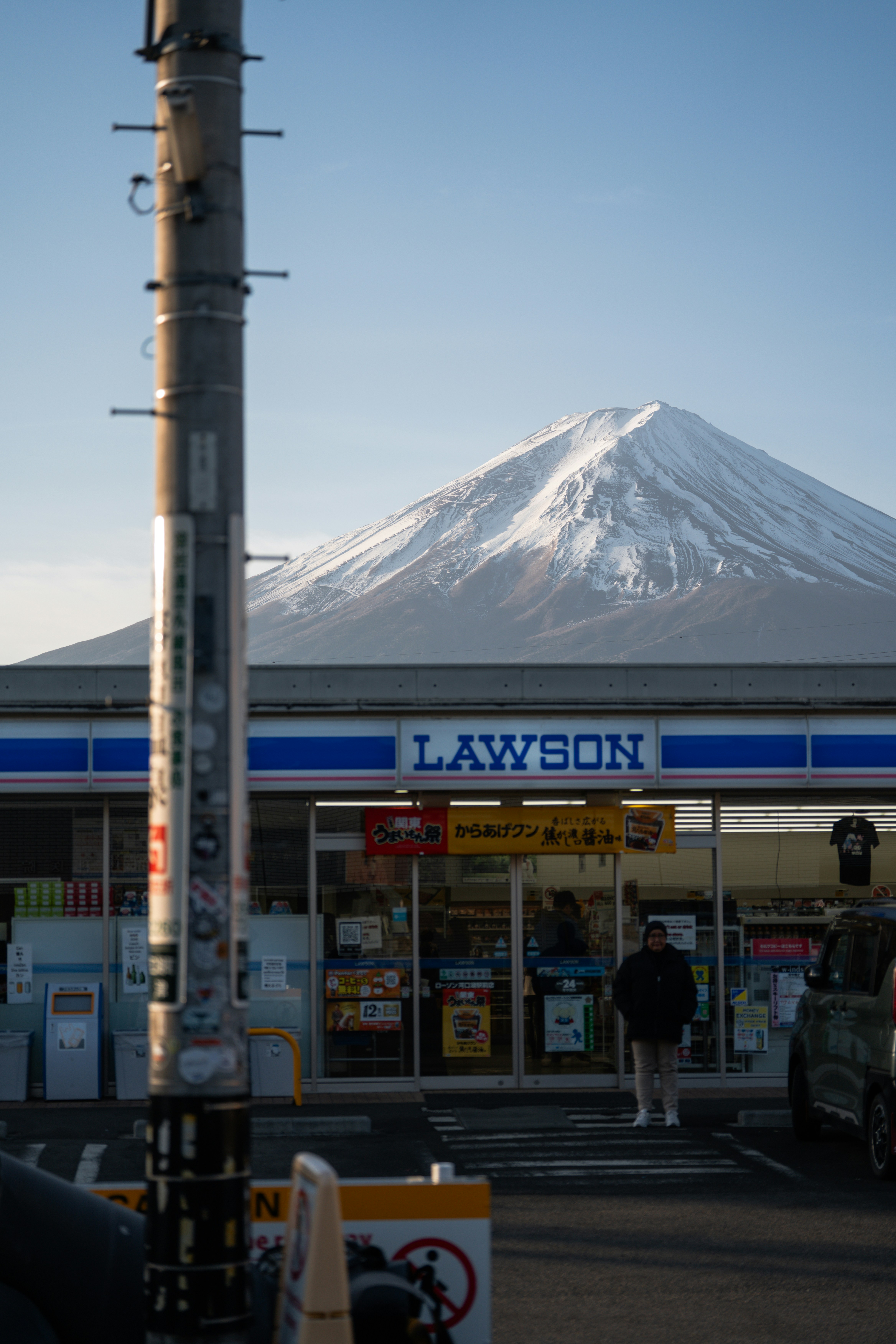 Snowy Mount Fuji over a Street-Level Lawson Storefront
