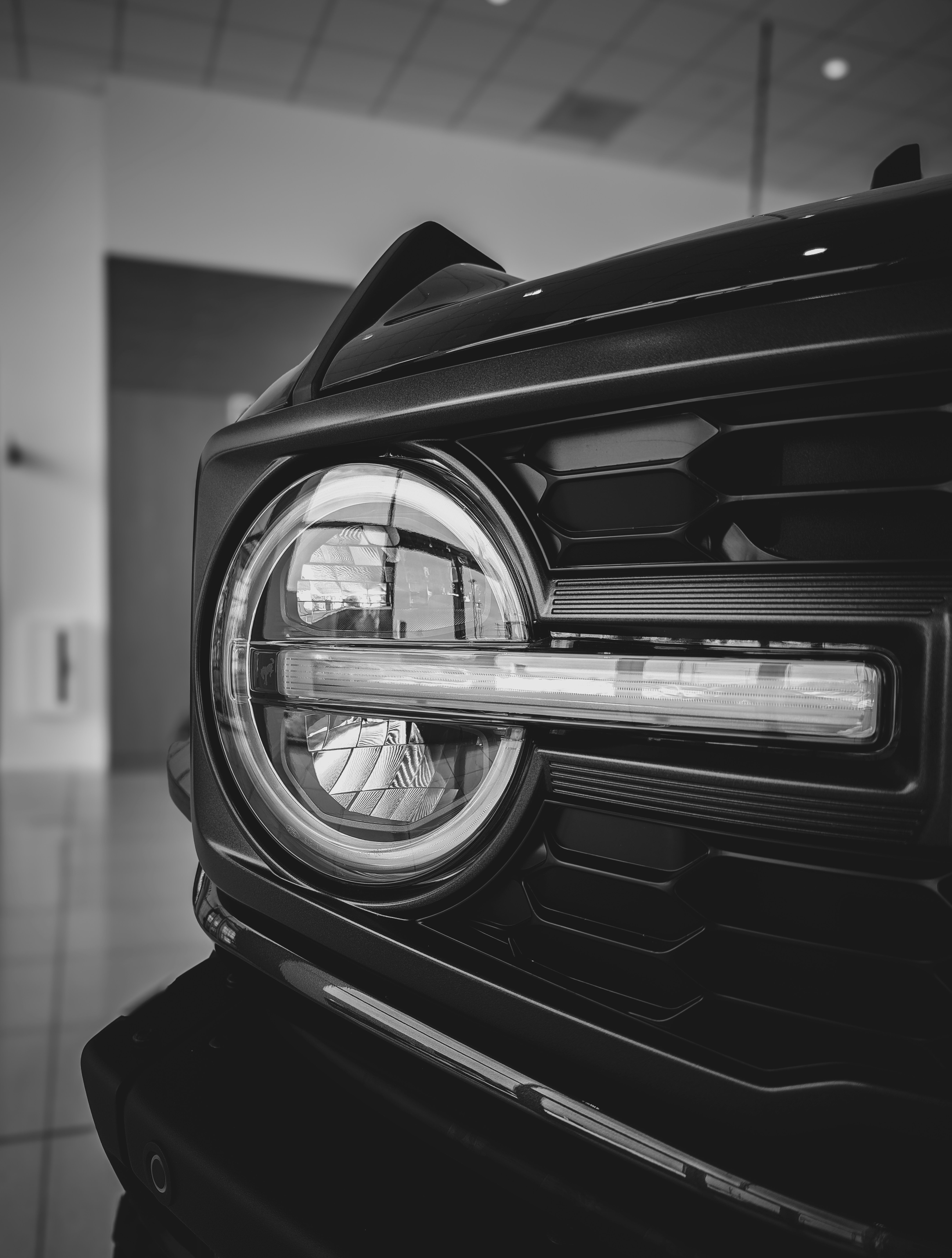 Close-up of a modern car headlamp and grill