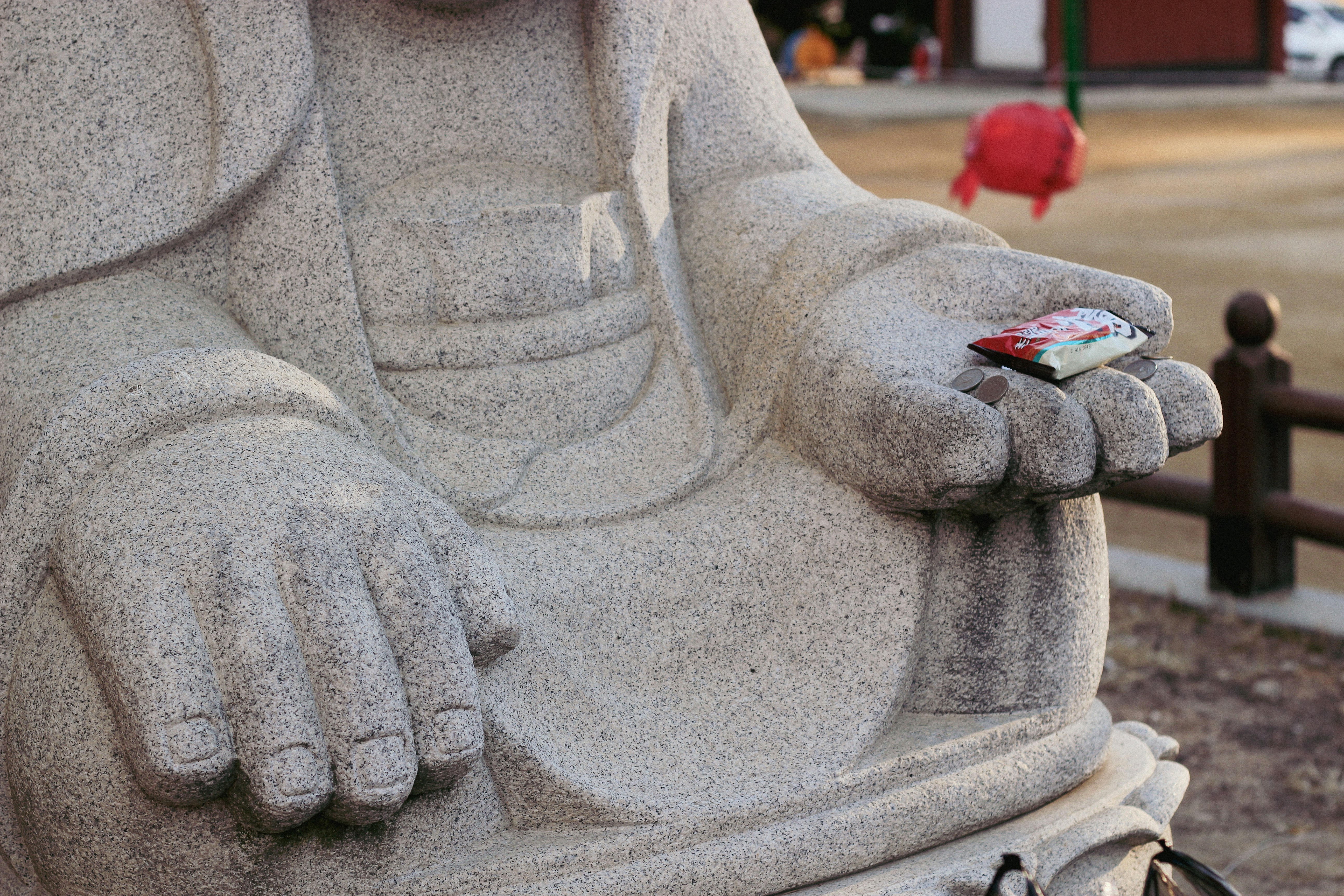 Gently Rested Offerings on a Stone Guardian