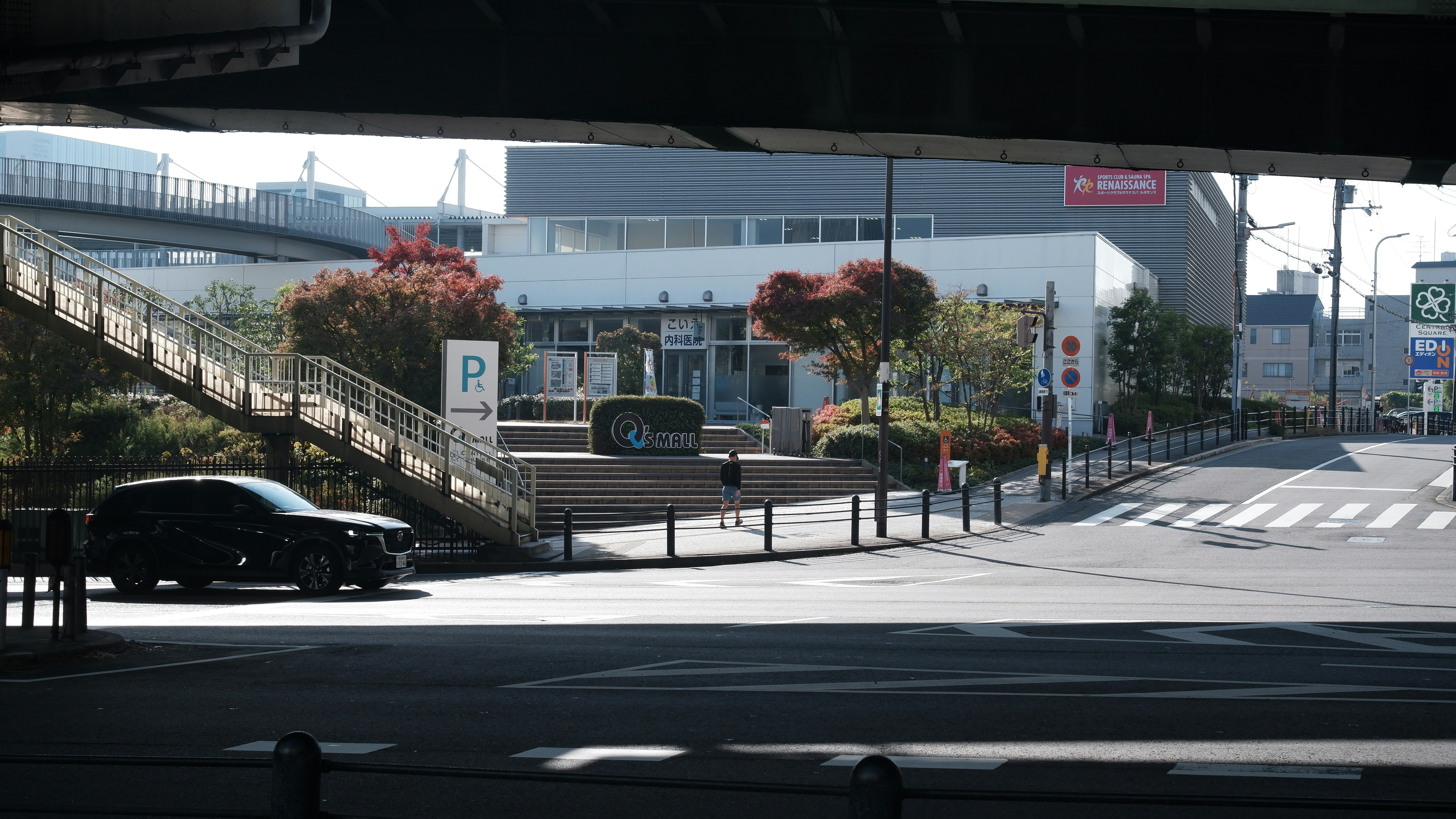 Shadows under the overpass: a quiet urban crossing