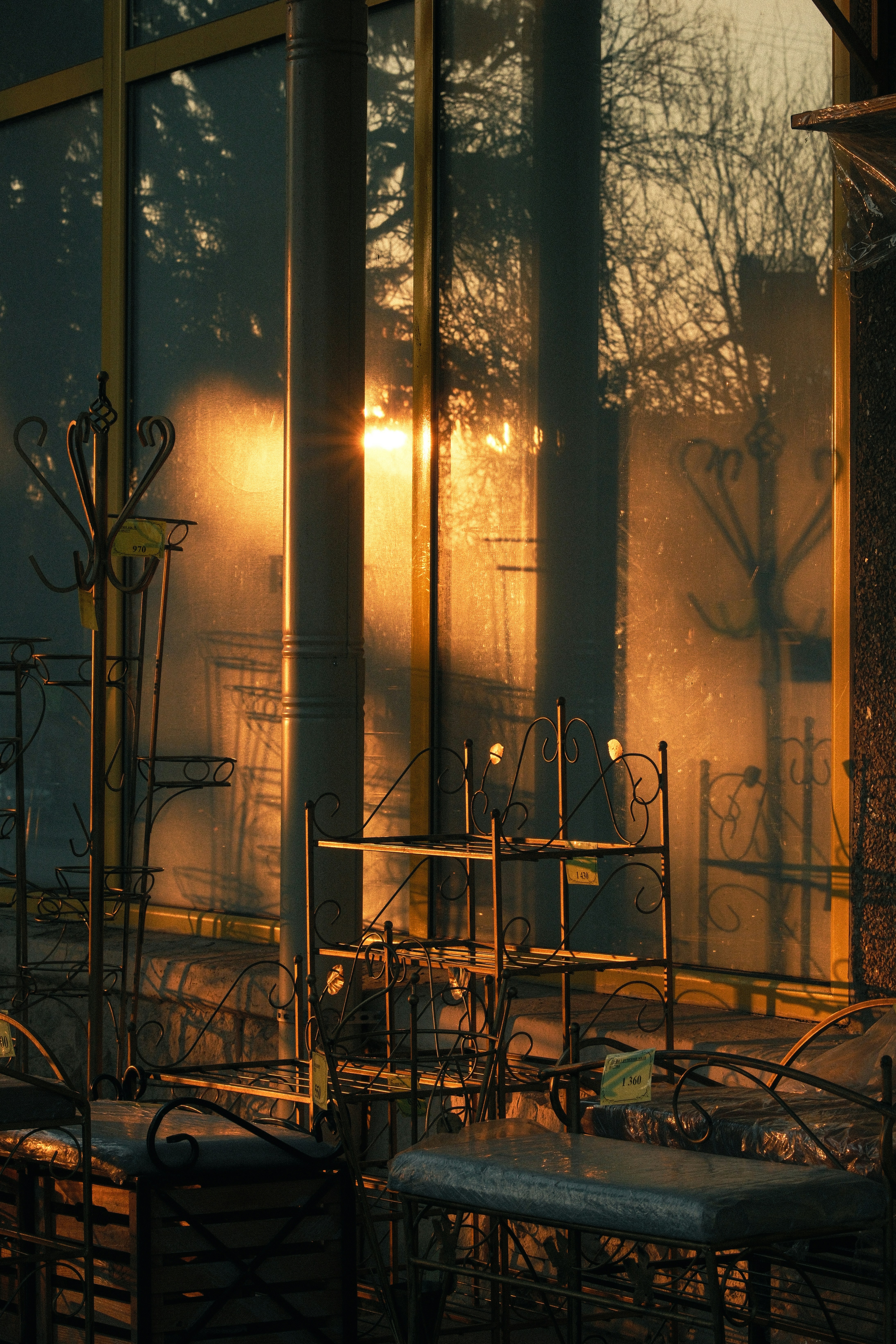 Golden Hour Through Wrought Iron: Bistro Reflections