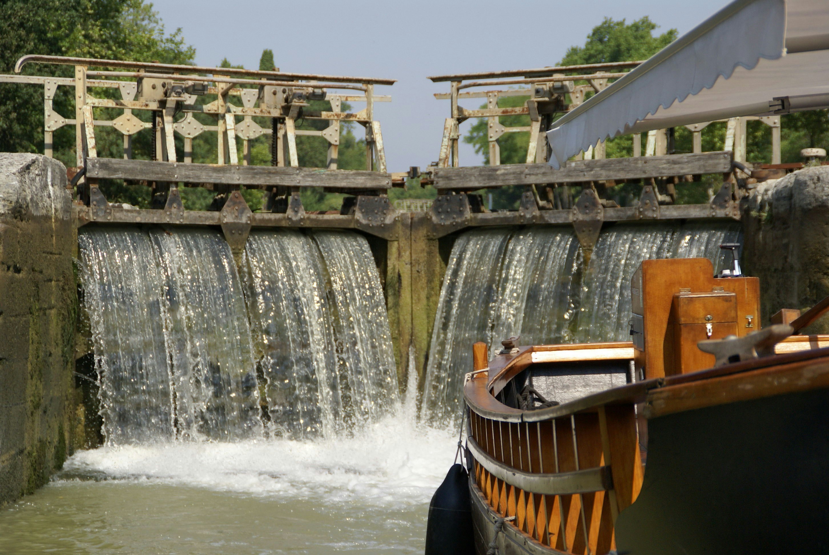 Water Authority: Cascading Gates and a Wooden Boat by the Canal