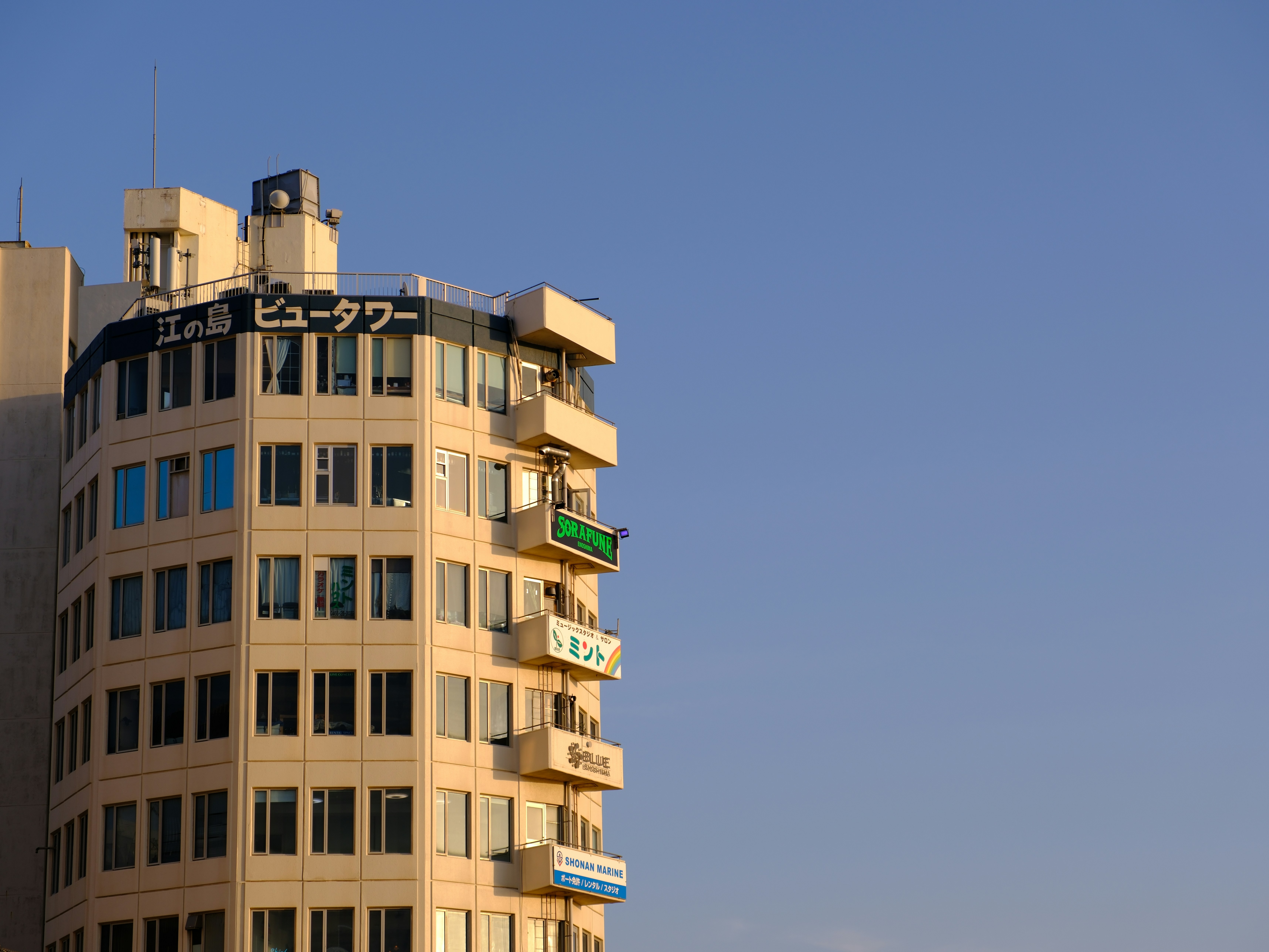 Towering Signage and Corner Facade in Sunlit Blue Sky