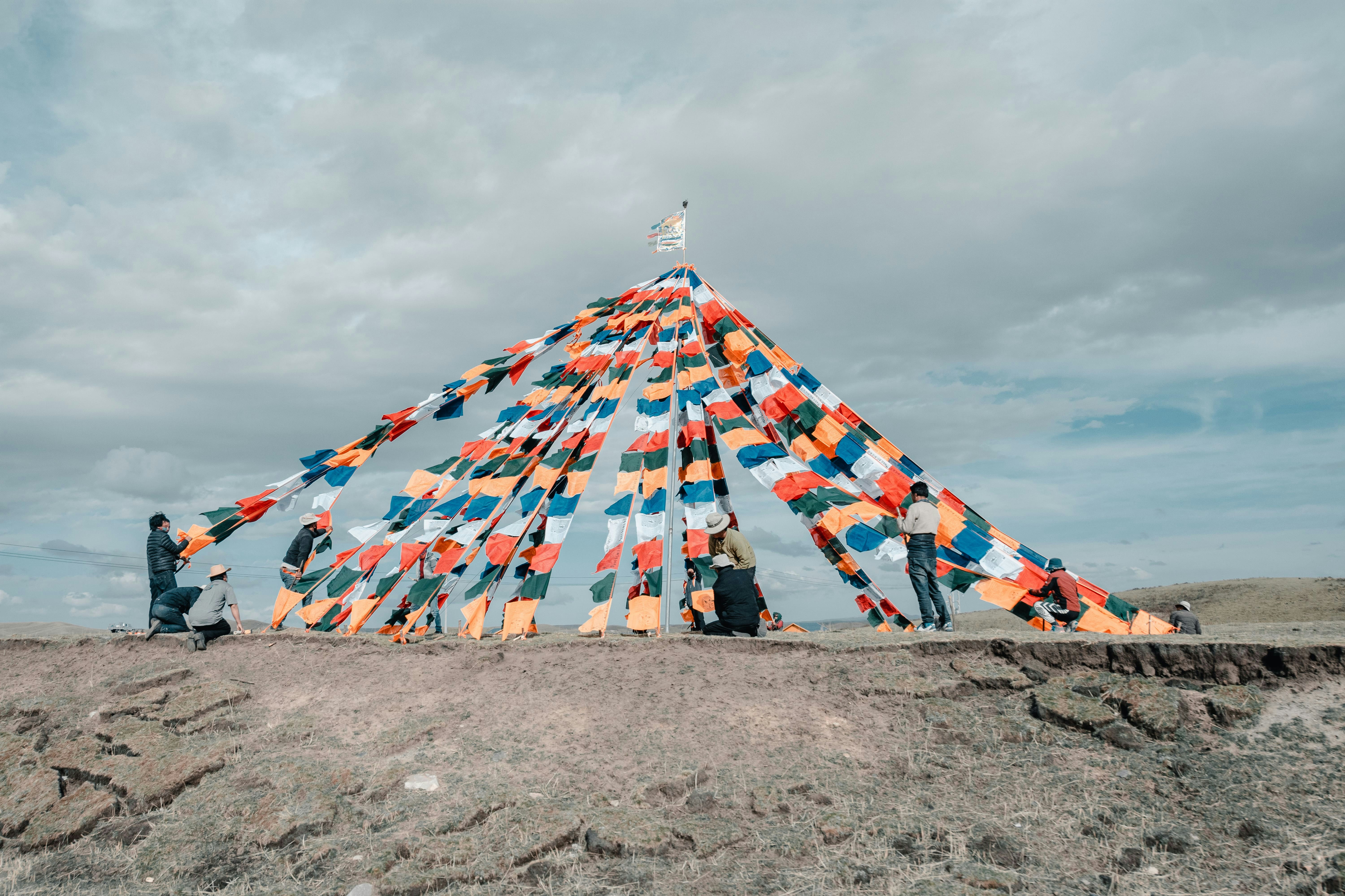 Colorful Skyward Tents: Prayer Flags Anchoring a Desert Horizon
