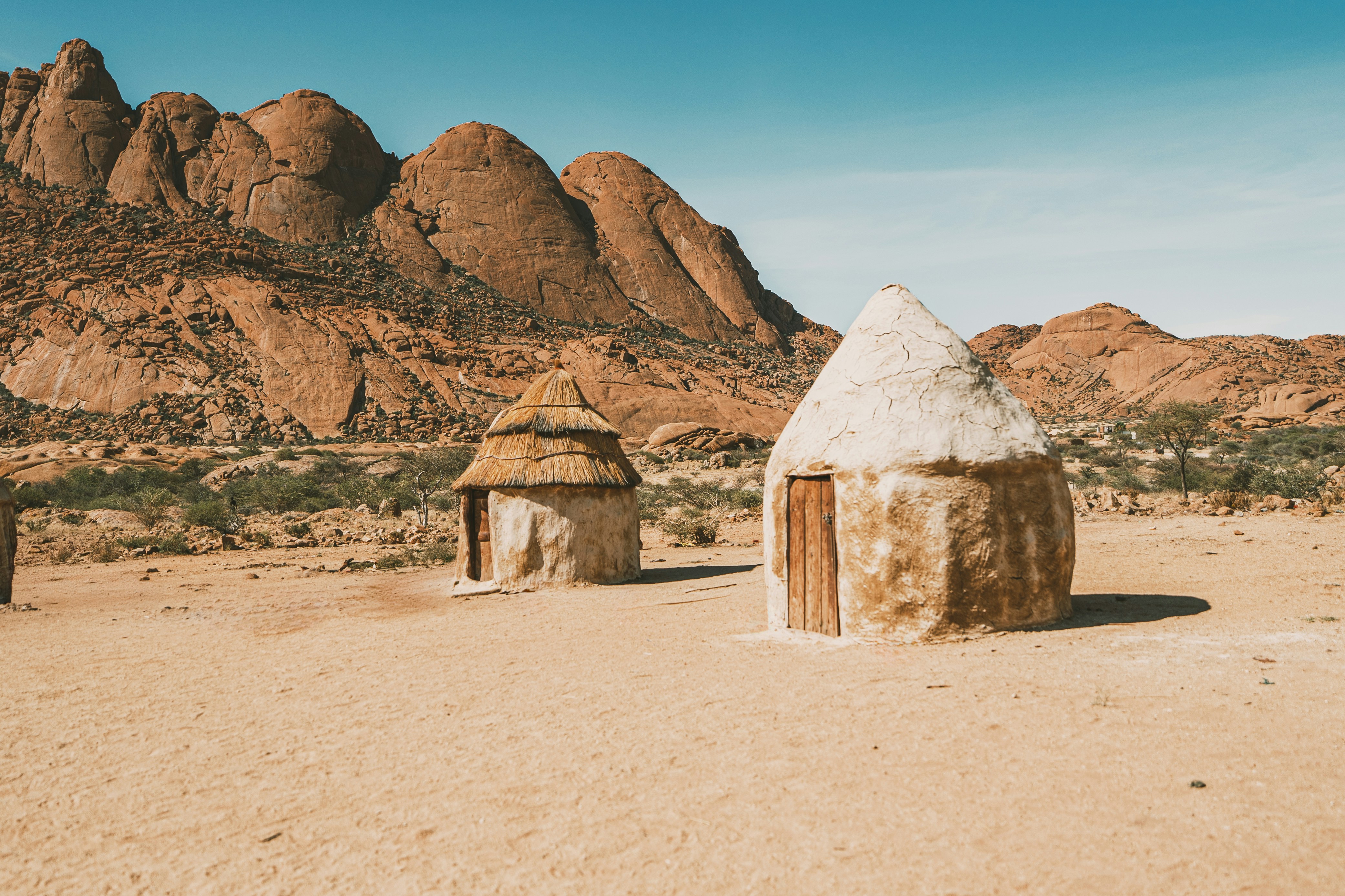 Desert Dwellings Against Rugged Granite Towers