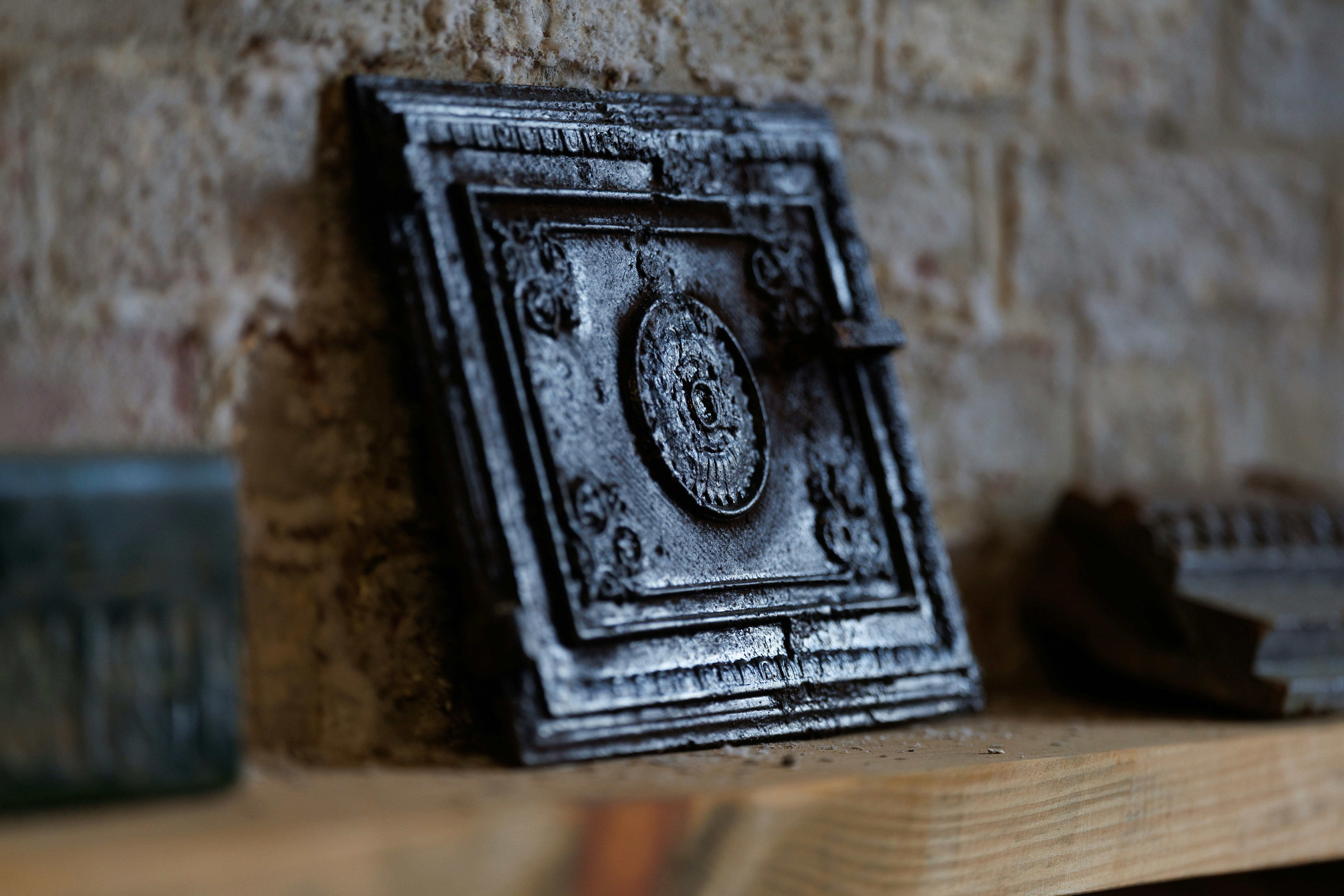 Weathered Vault Door Resting on a Wooden Shelf