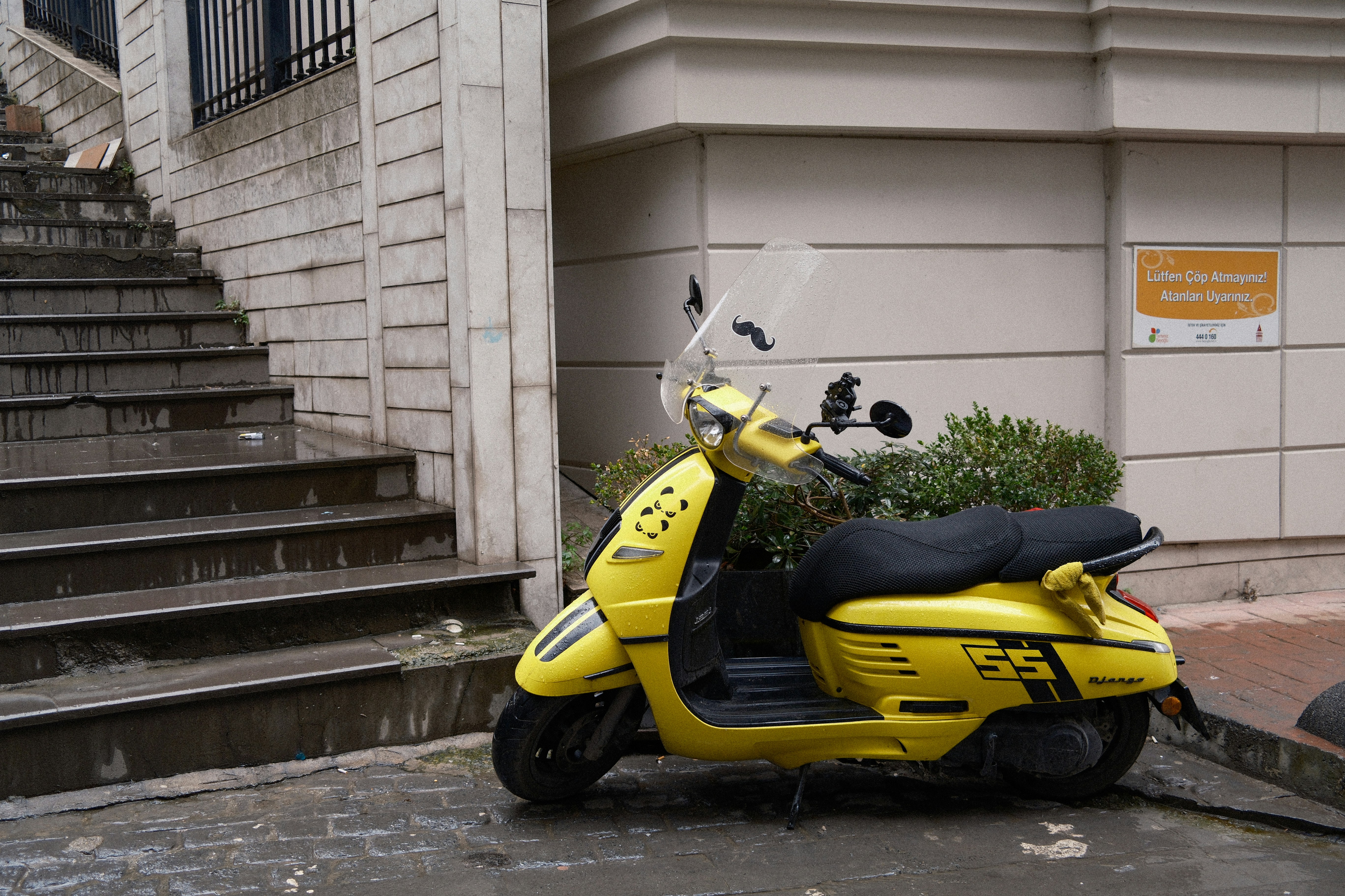 Sunny Stallion: A Bright Yellow Scooter at the Steps