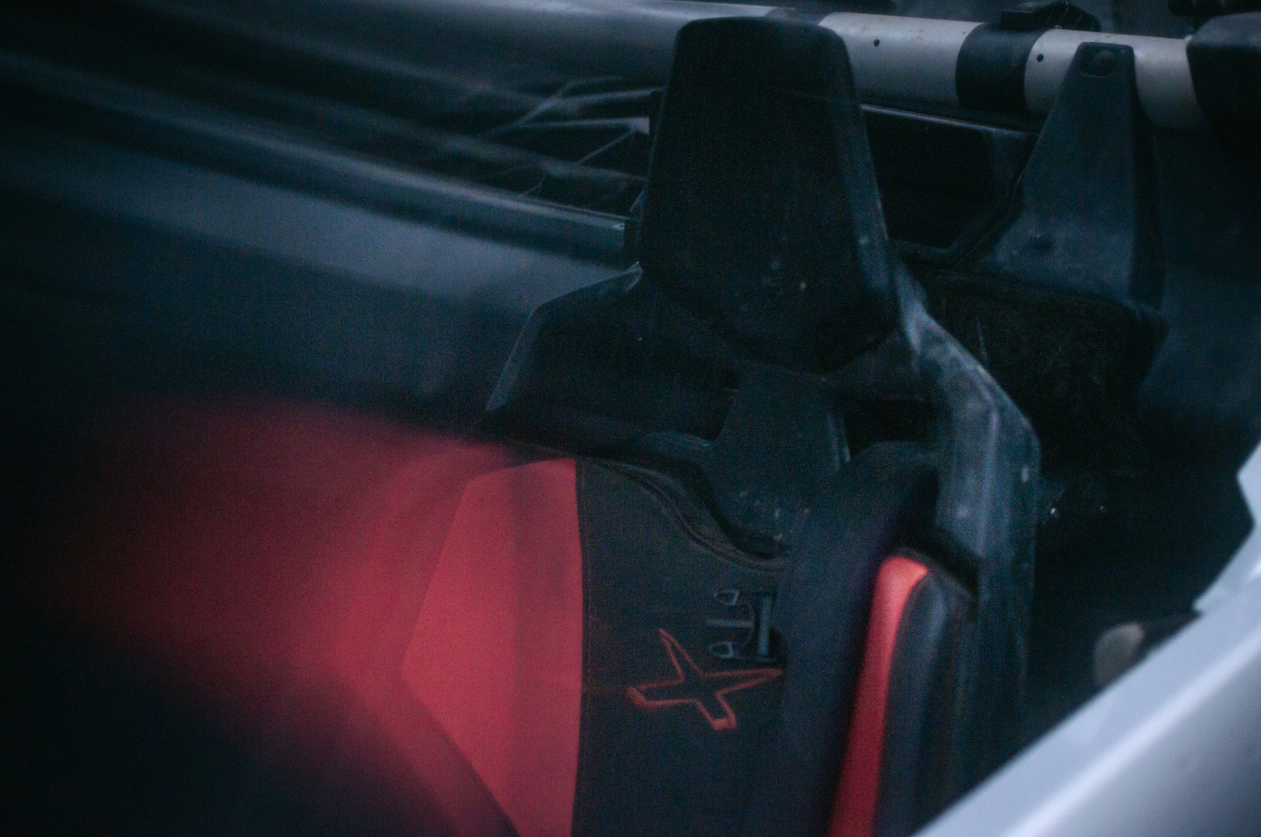 Red Tooling in the Shadow: A Close-Up of a Handgun Trigger Mechanism