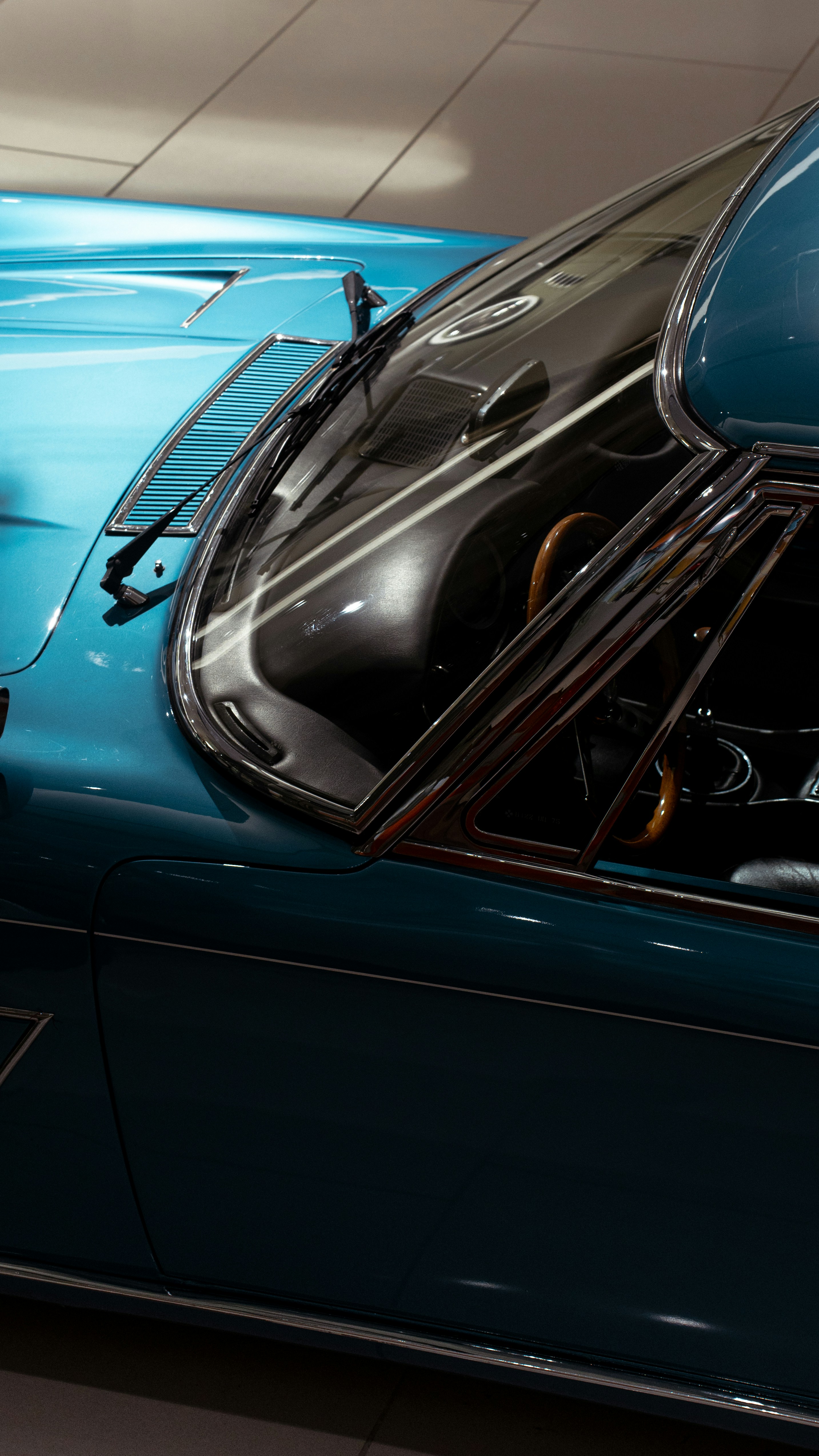 Aqua Classic: The Teal Hood and Chrome Frame of a Vintage Cabriolet