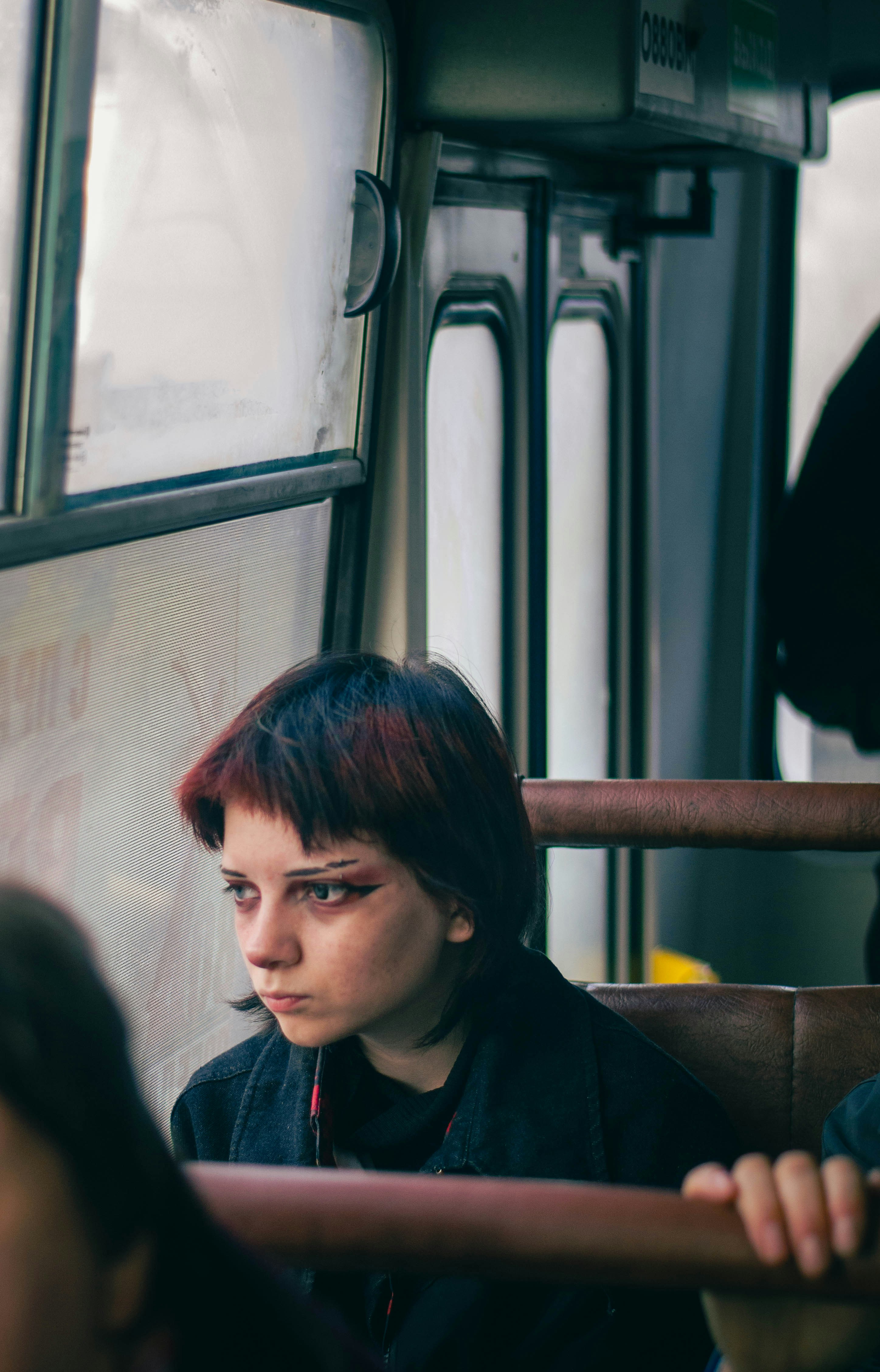 Muted Reflection: A Quiet Moment Among Bus Windows