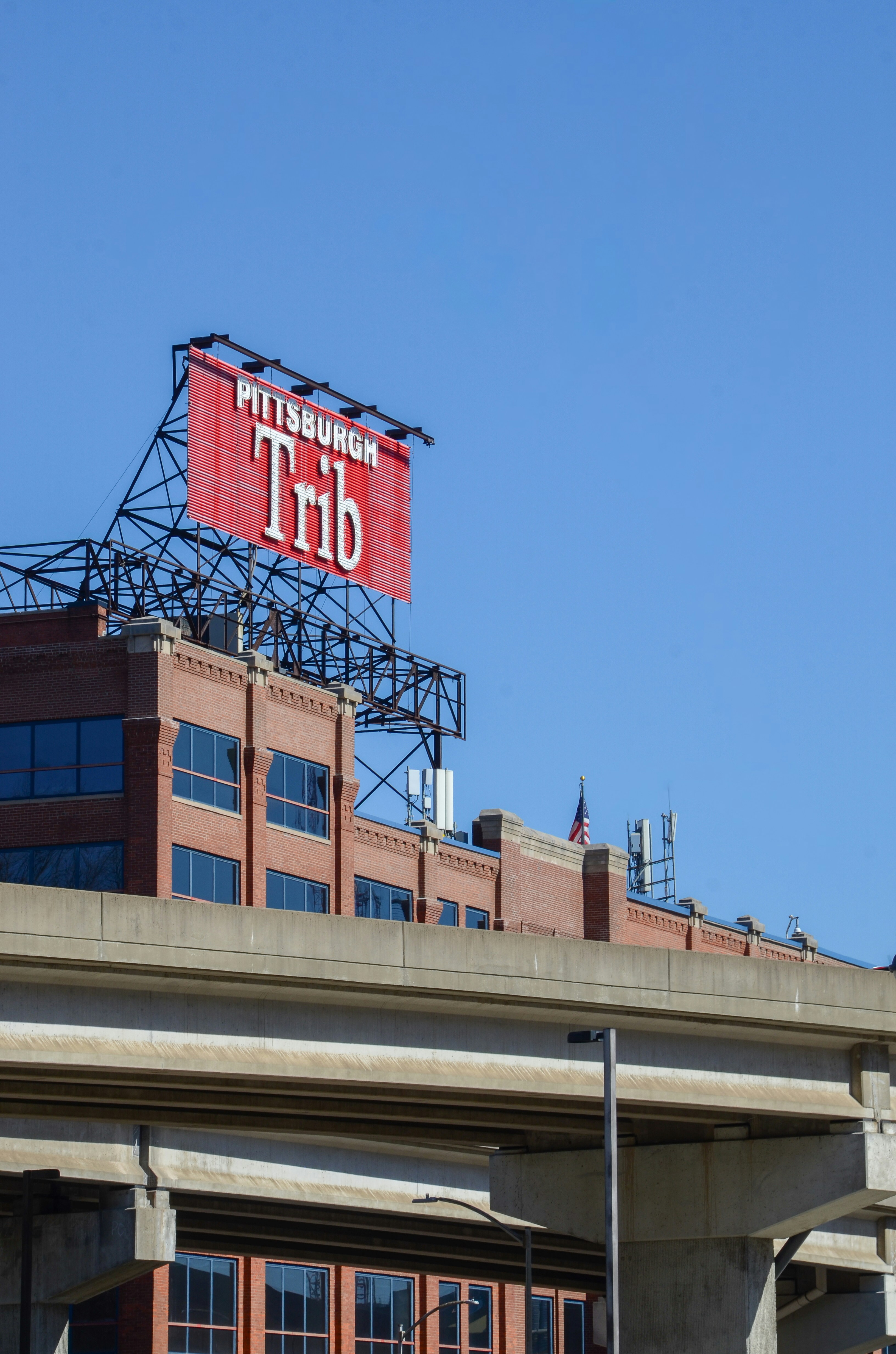 Red Penned Sign Over City Red Bricks