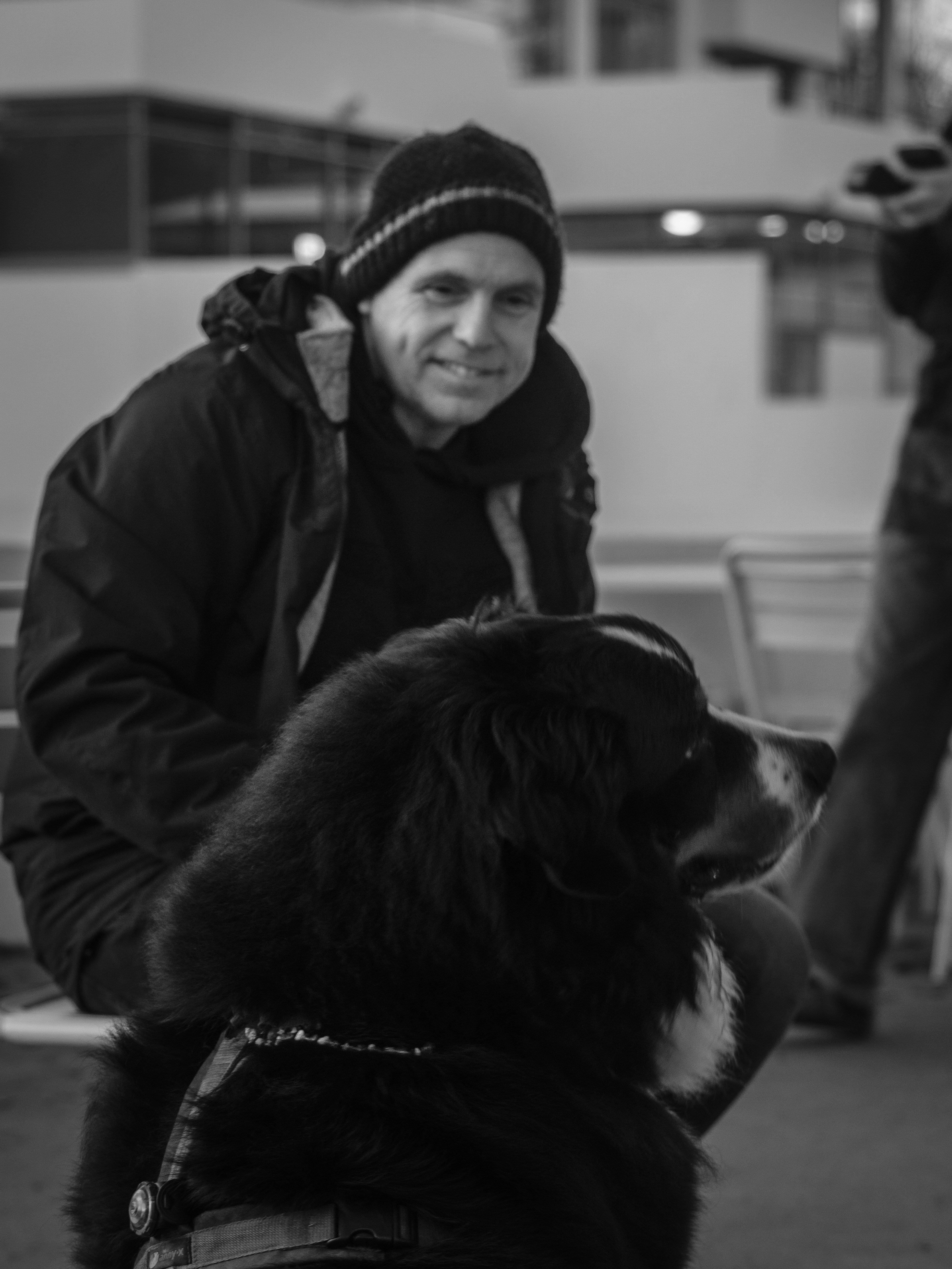 Portrait with a Patient Companion: Man in Beanie and a Dog in a Quiet Vignette