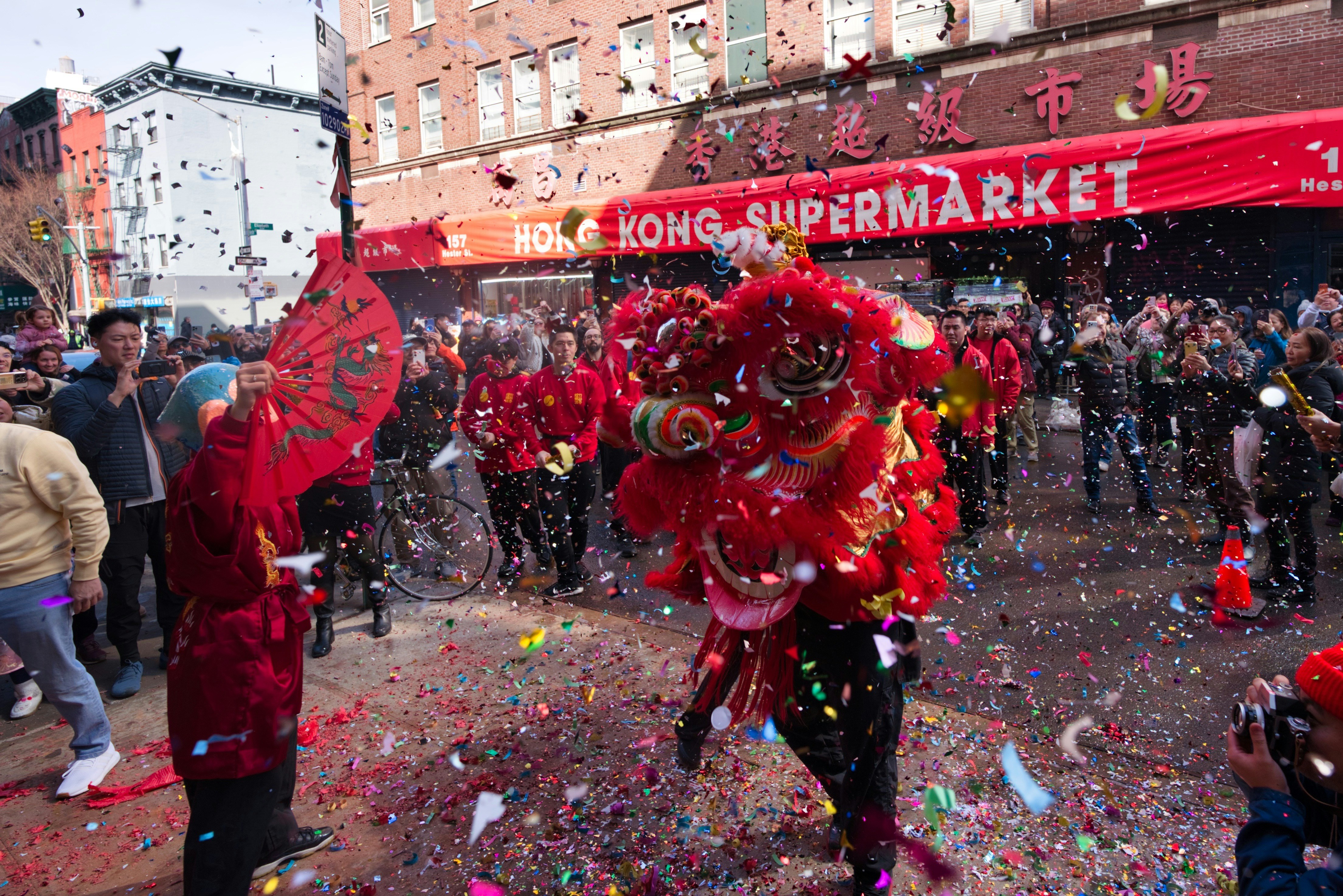 New York, New York - February 28, 2026: Traditional lion dance troupes and thousands of spectators gather on Hester Street for the "Super Saturday" Chinatown Lion Dance Festival and ceremonial firecracker display. Celebrating the 2026 Lunar New Year—the Year of the Fire Horse—the event features rhythmic drumming, vibrant costumes, and the traditional lighting of firecrackers to ward off evil spirits and bring good fortune. The massive street festival in Manhattan's Chinatown is a cornerstone of the city's cultural calendar, showcasing ancestral Chinese traditions, martial arts-infused dance performances, and community celebrations that draw residents and tourists to the historic neighborhood for the final peak of the New Year festivities.
