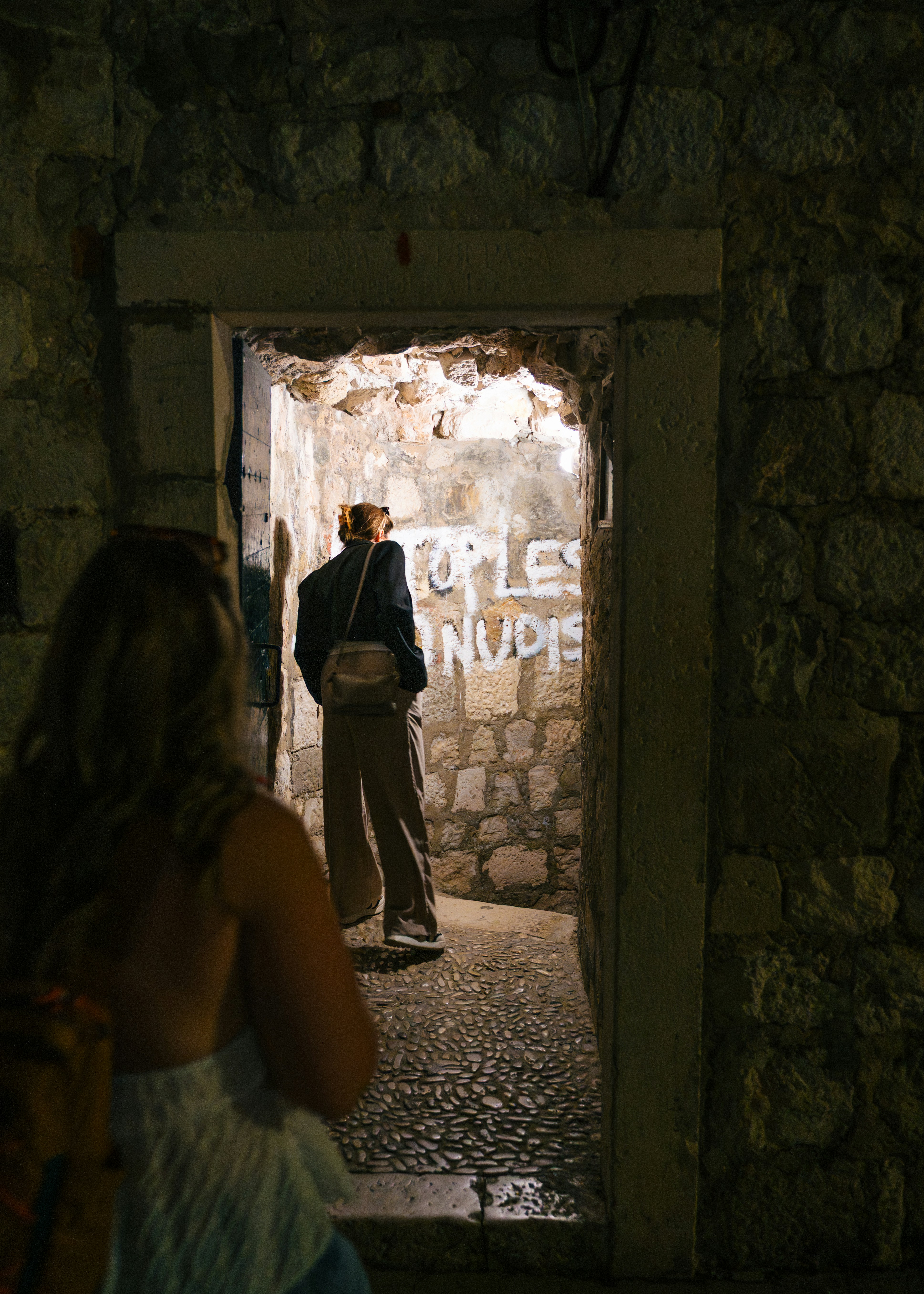 Through the Stone Gate: A Quiet Moment in the Hidden Passage