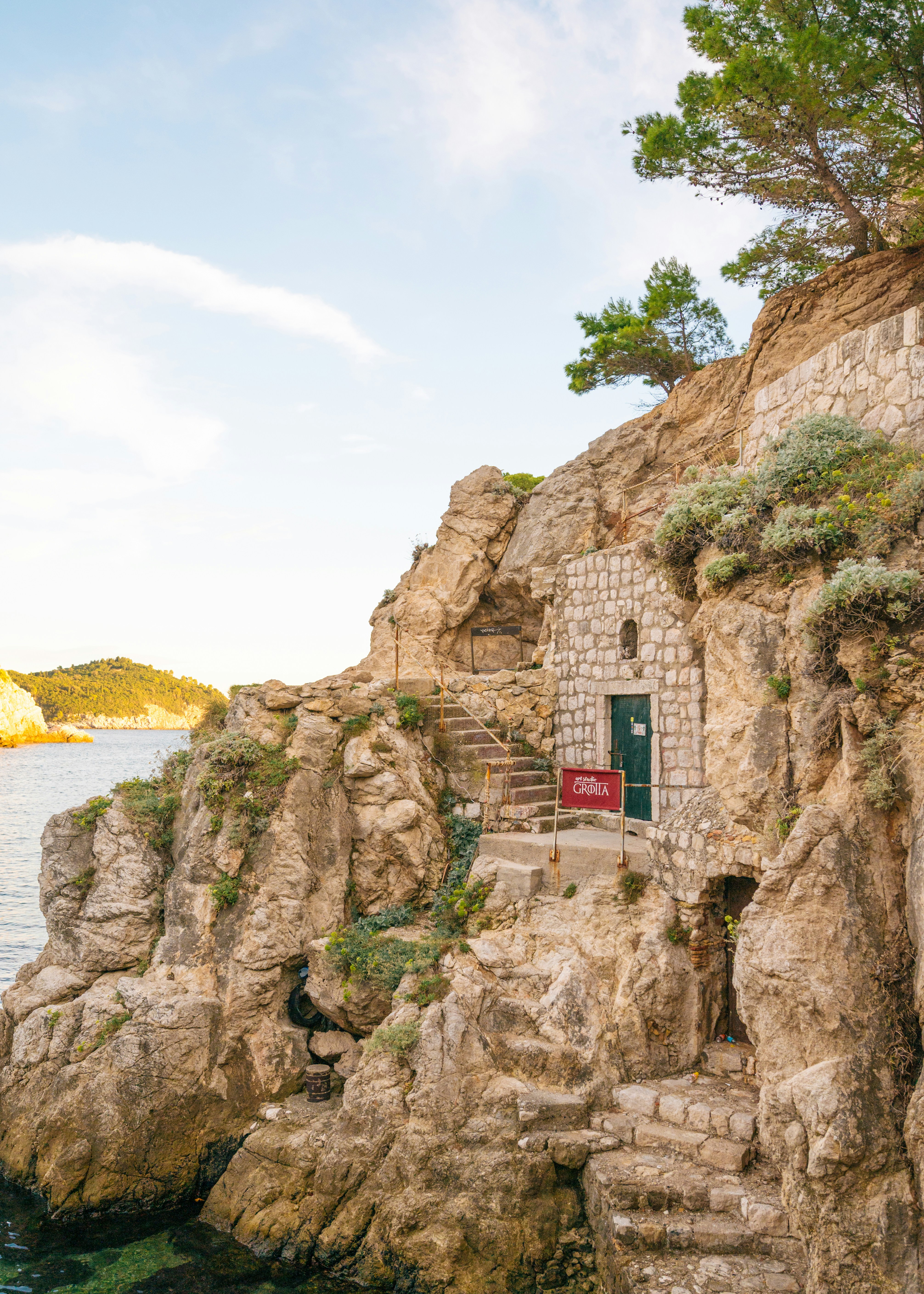 Stone Stairway to the Cove: Cliffside Fortress by the Sea