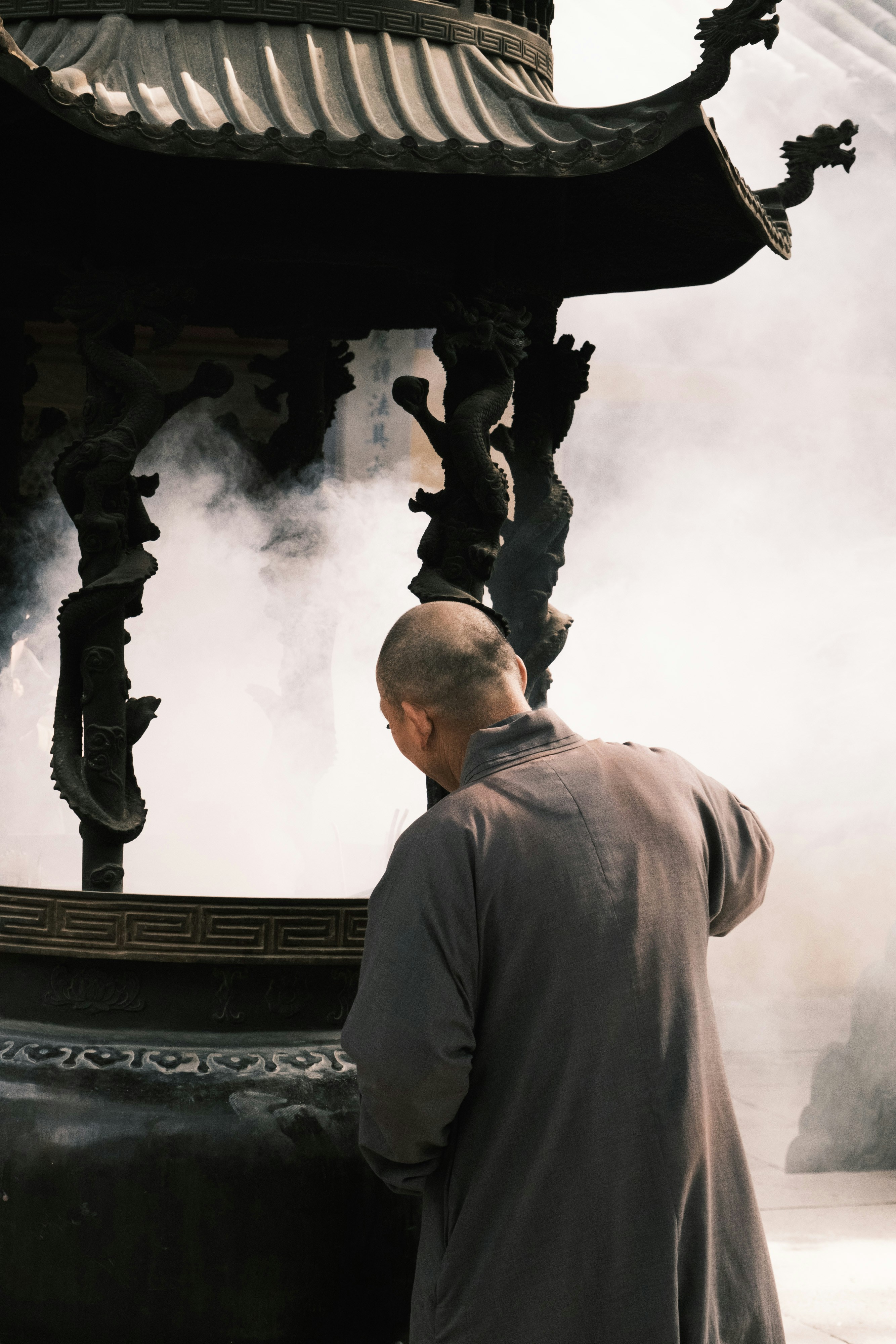Breath in the Smoke: A Monk Silent Amid the Ancient Urn
