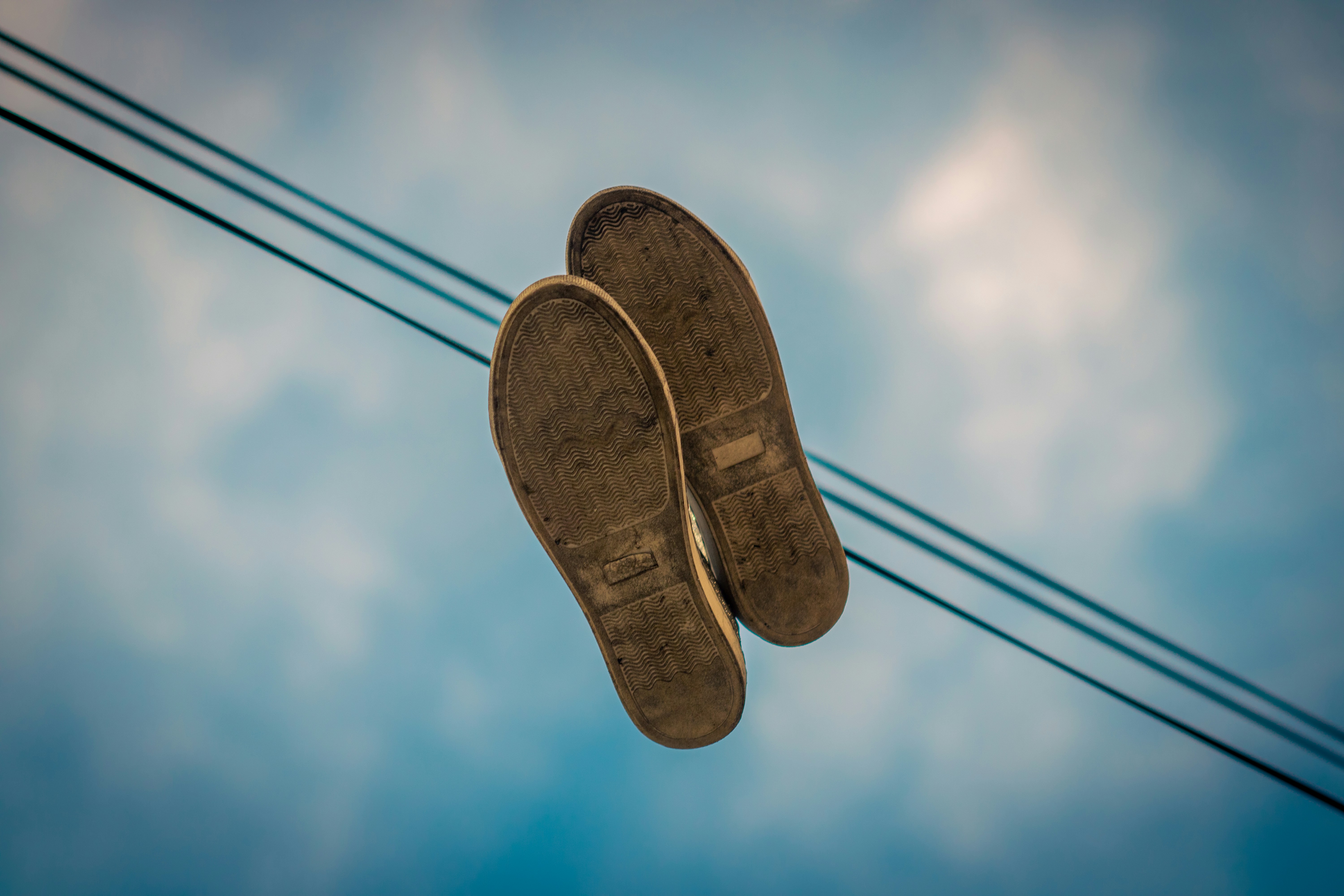 Earthen Boots on a Sky-Blue Wire