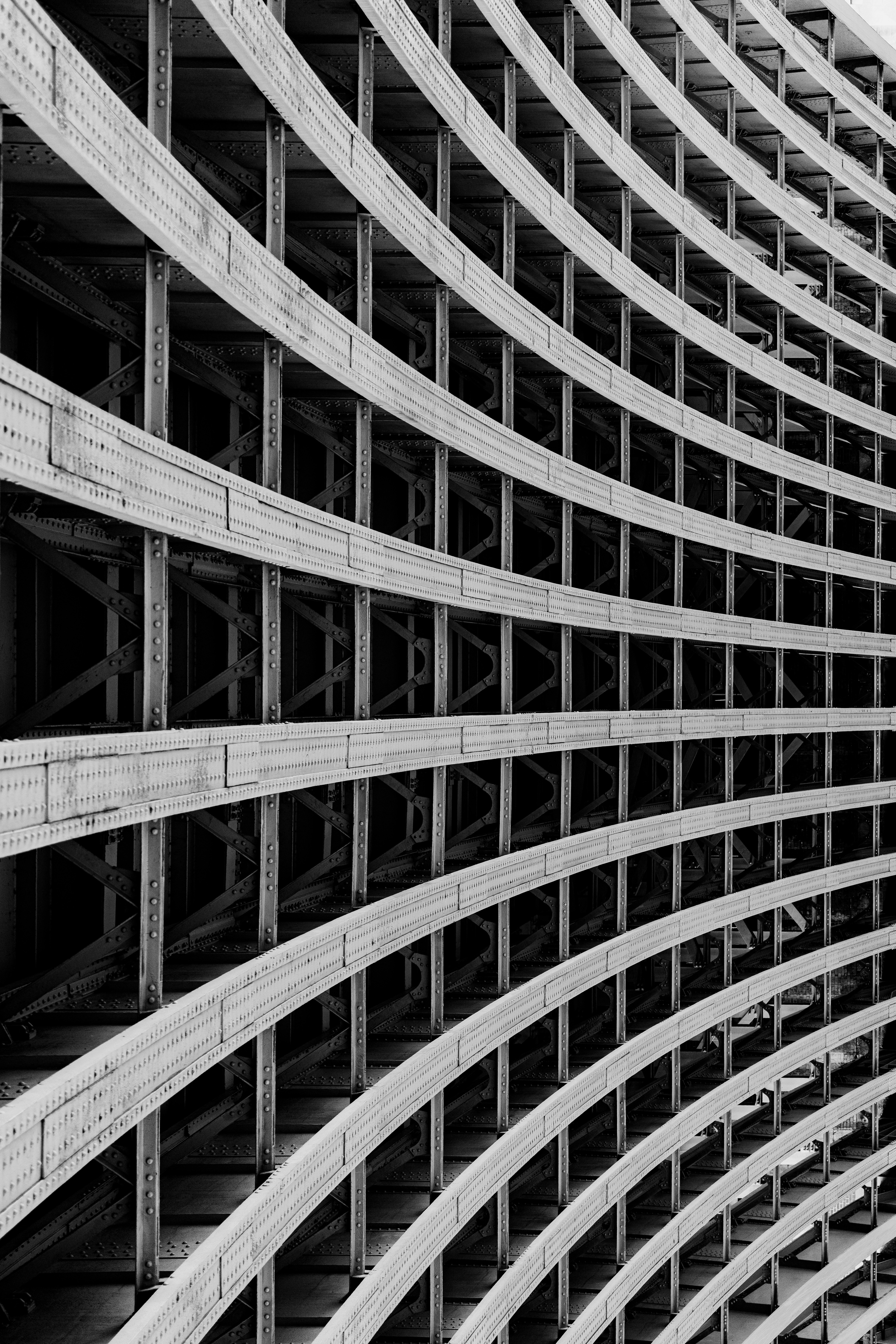 Curved Iron Rhythm: A Monochrome Portrait of Industrial Arches