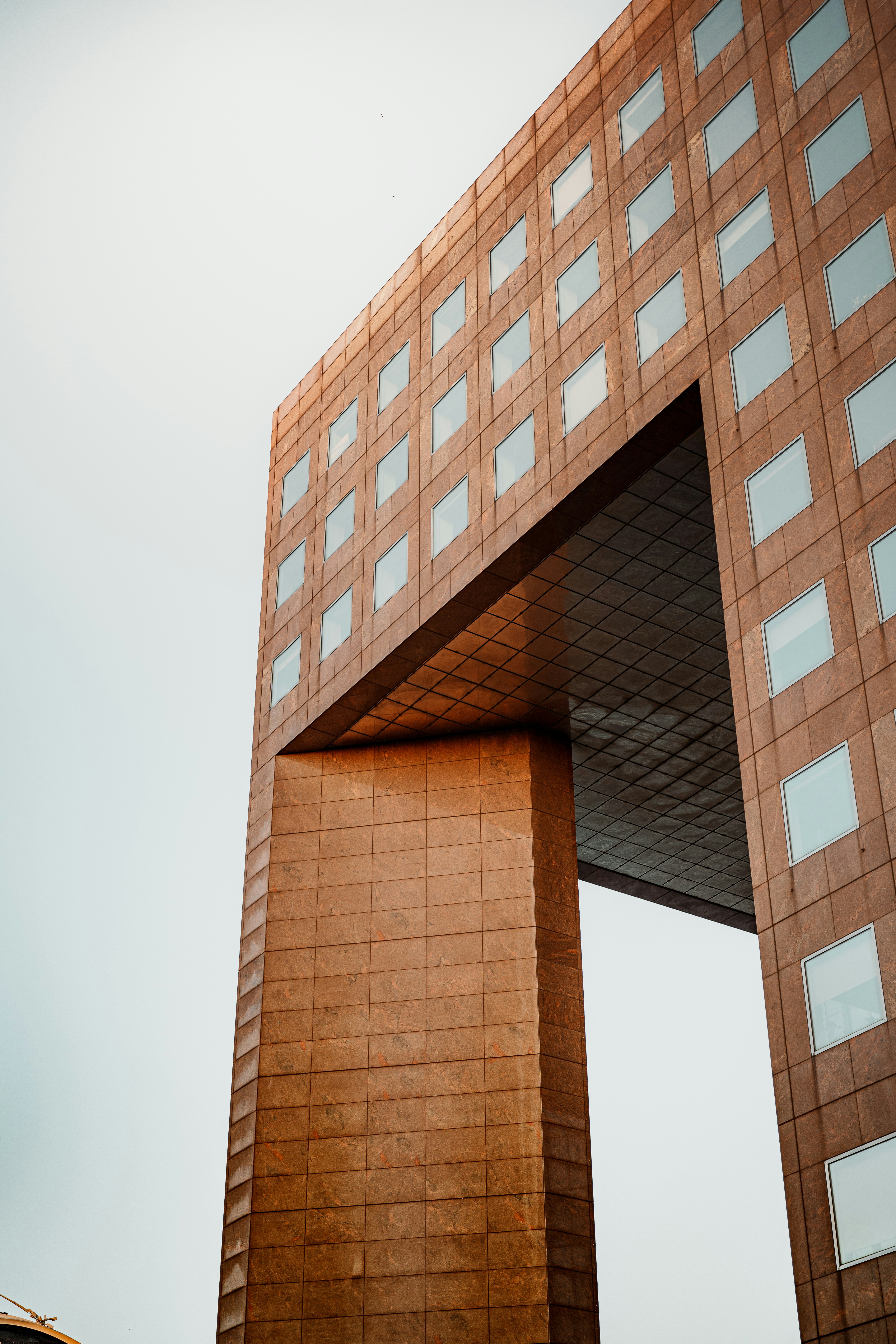 Gateway to Geometry: A Brown Archway Reaching Across the Sky