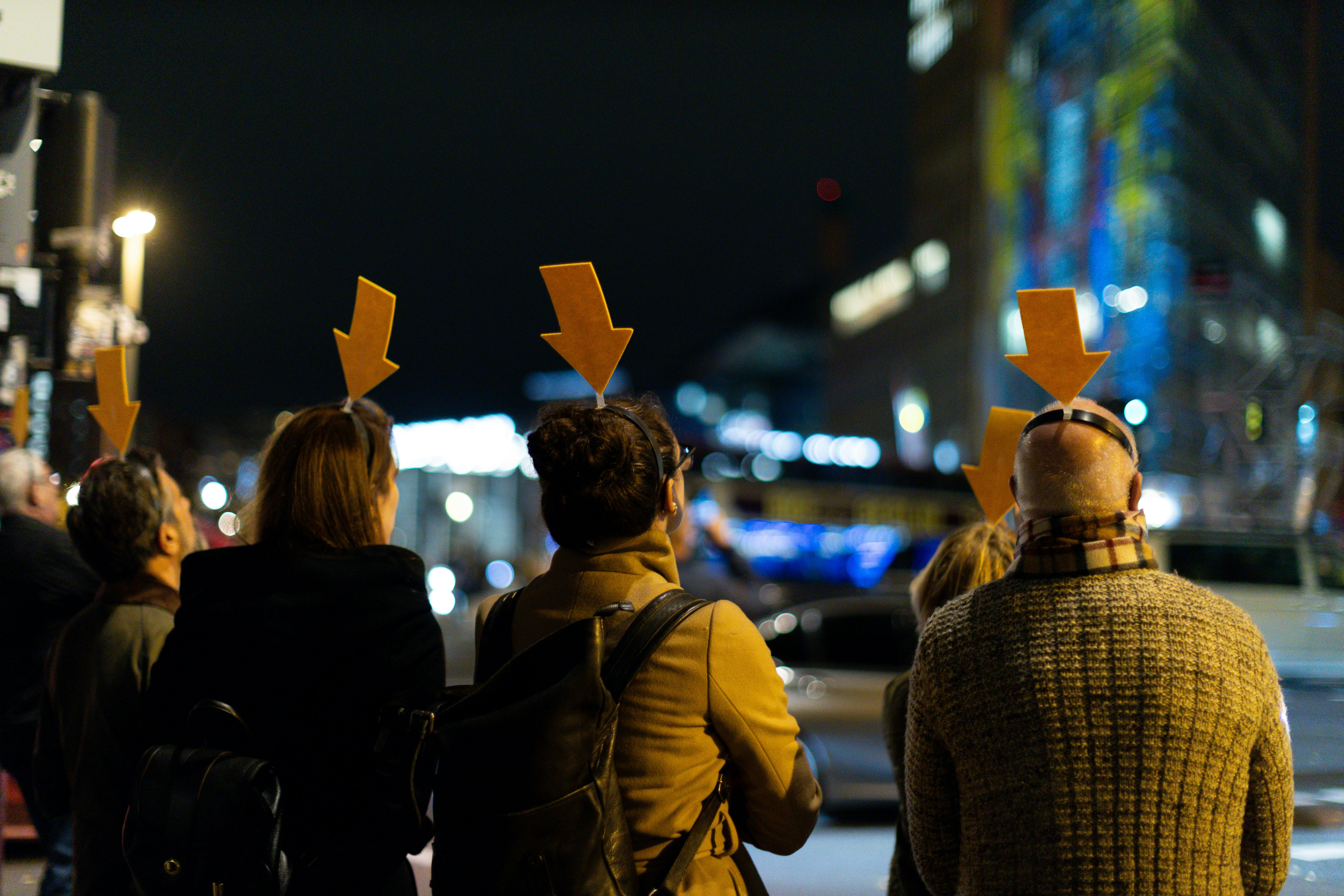 Night Street Echoes: Arrows Above the Crowd