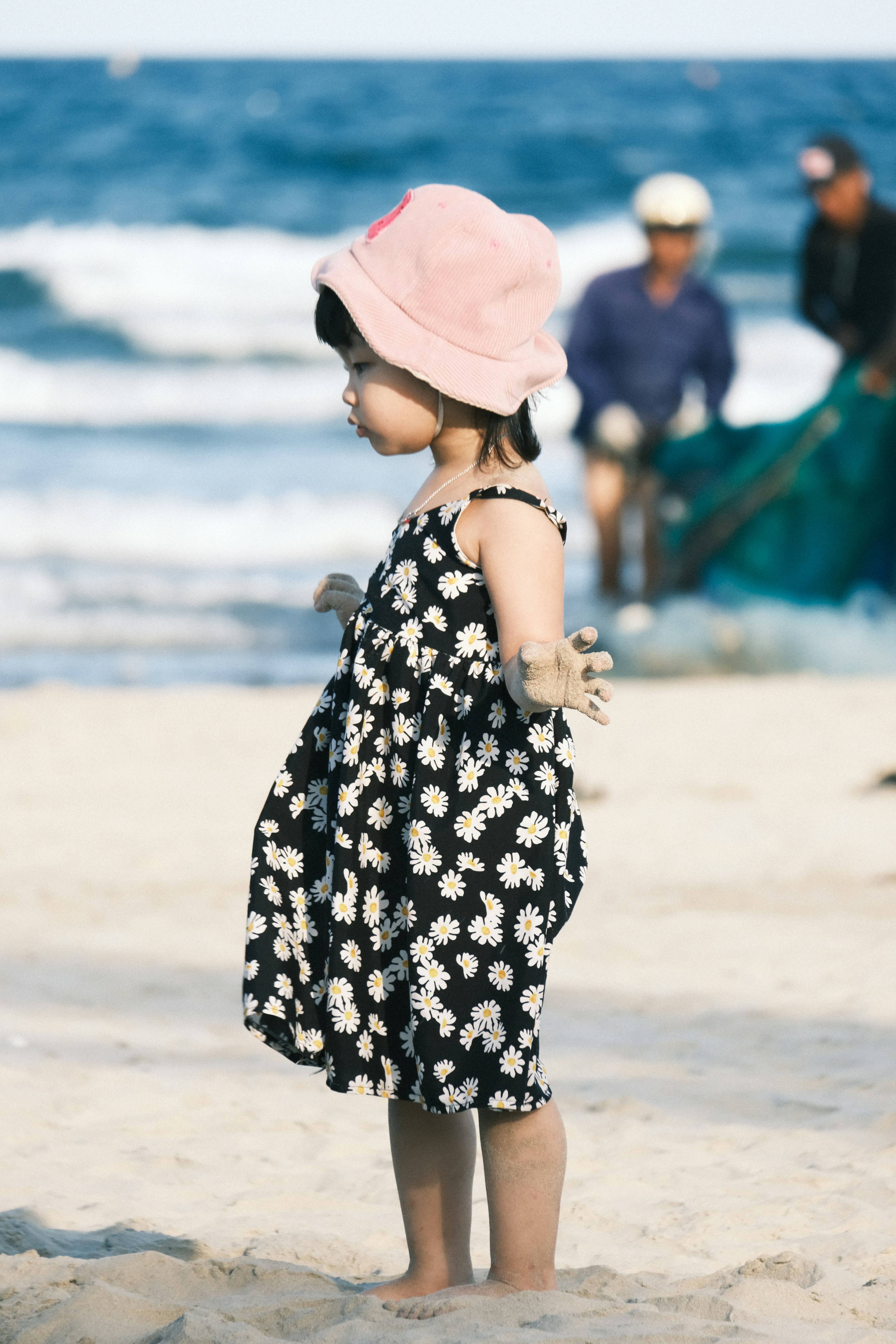 Daisy-Patterned Dress, Pink Hat, Quiet Beach Moment