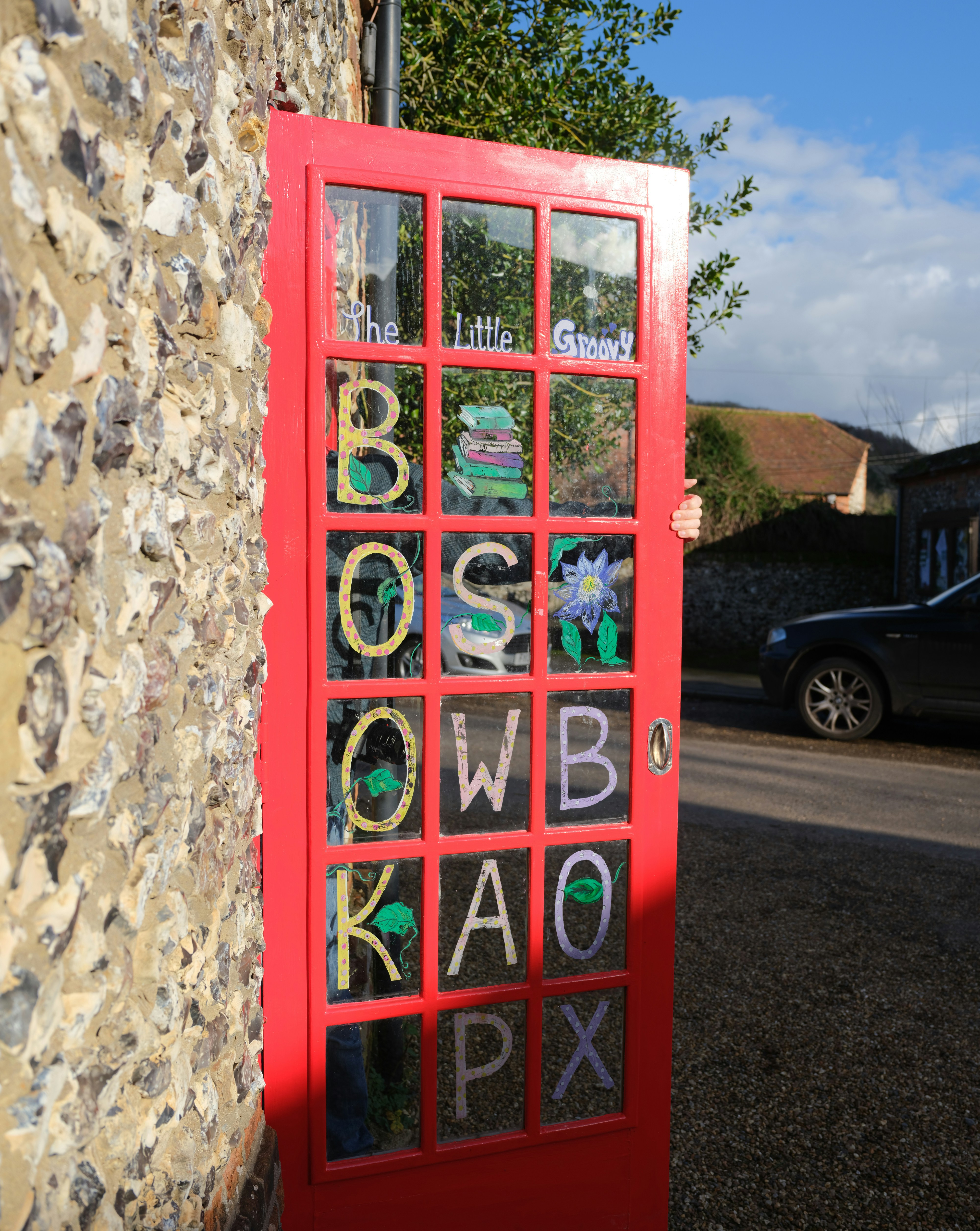 Red door with "the little goat book swap" sign