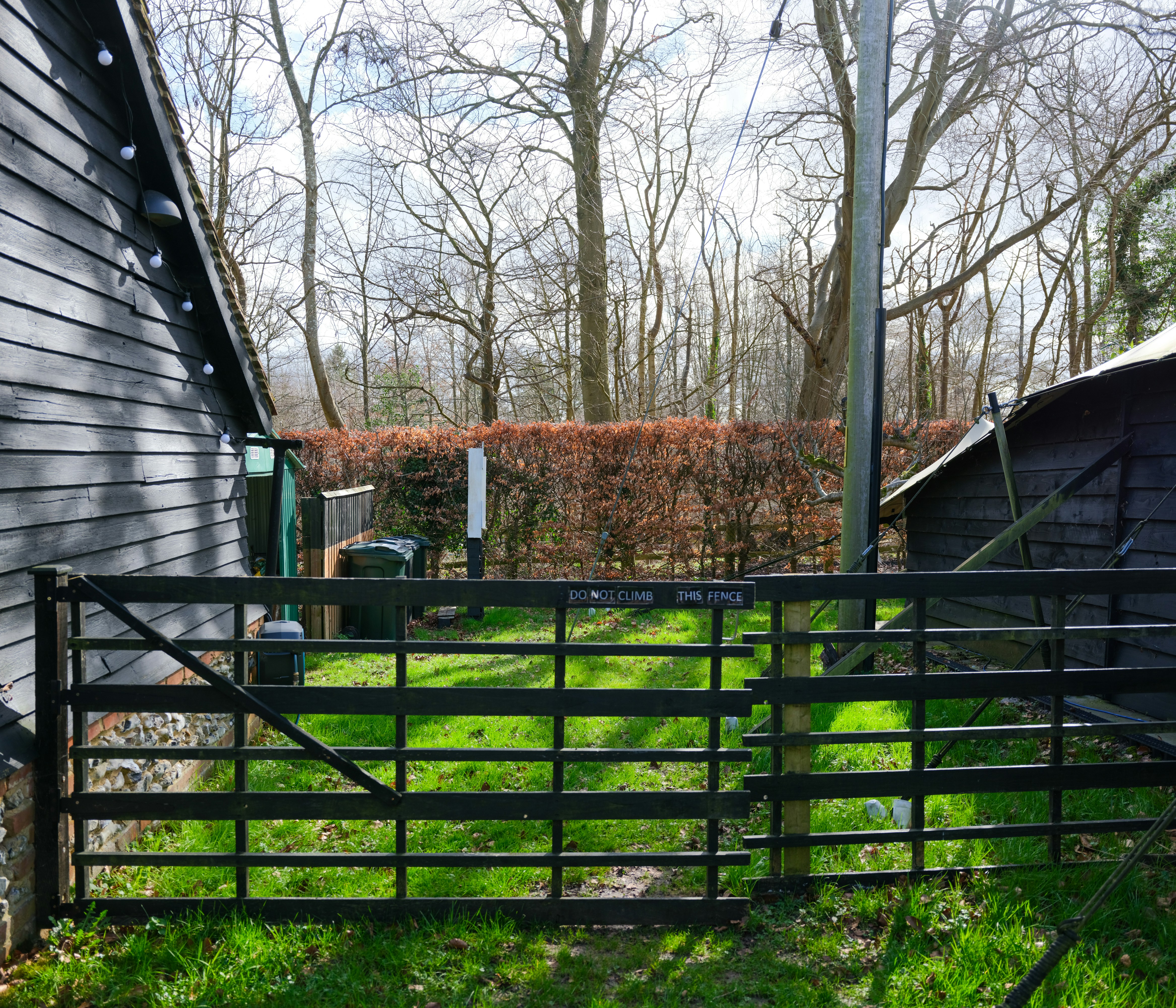 Gate to Stillness: A Rural Yard Framed by Weathered Sheds
