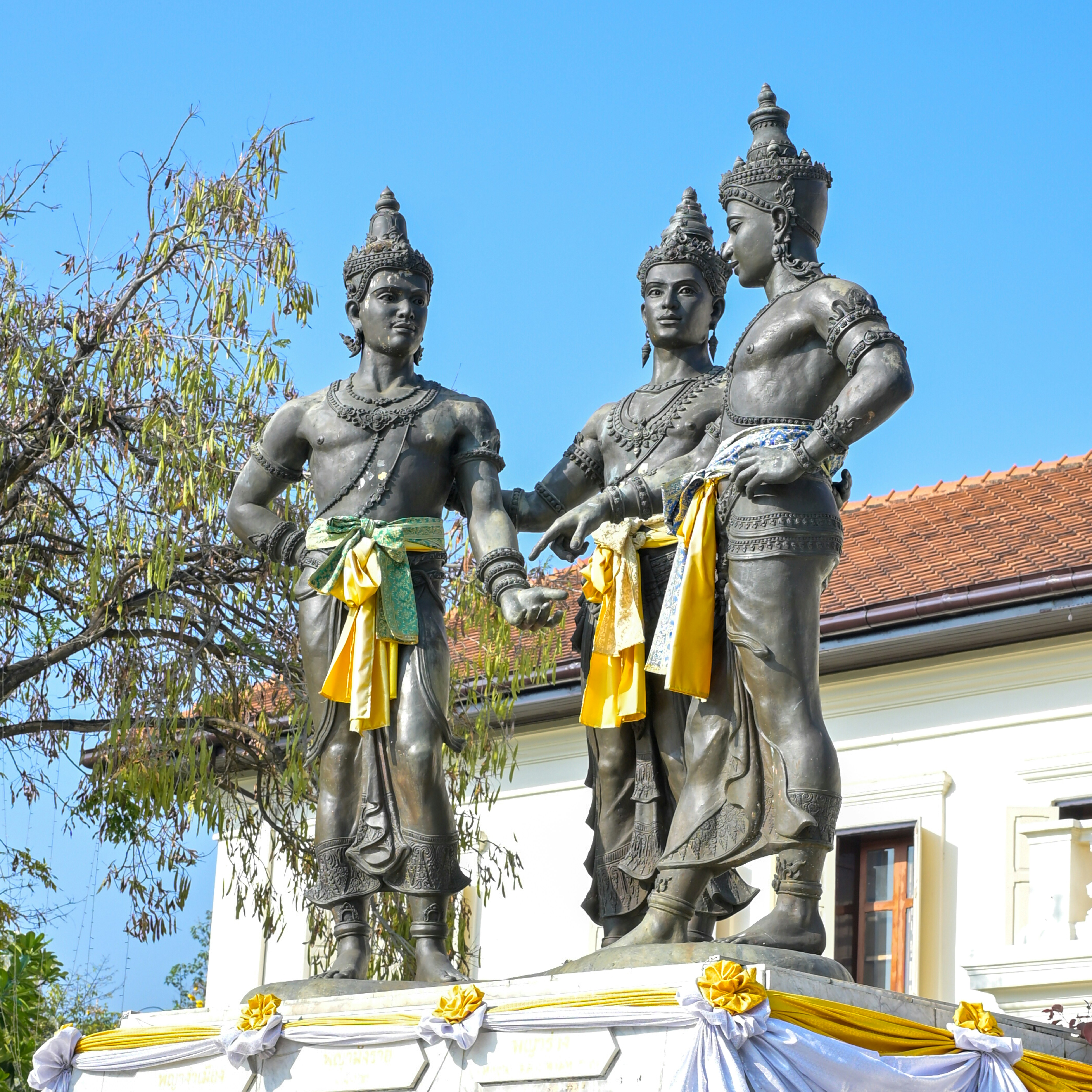 Triad of Guardian Statues Under a Blue Sky