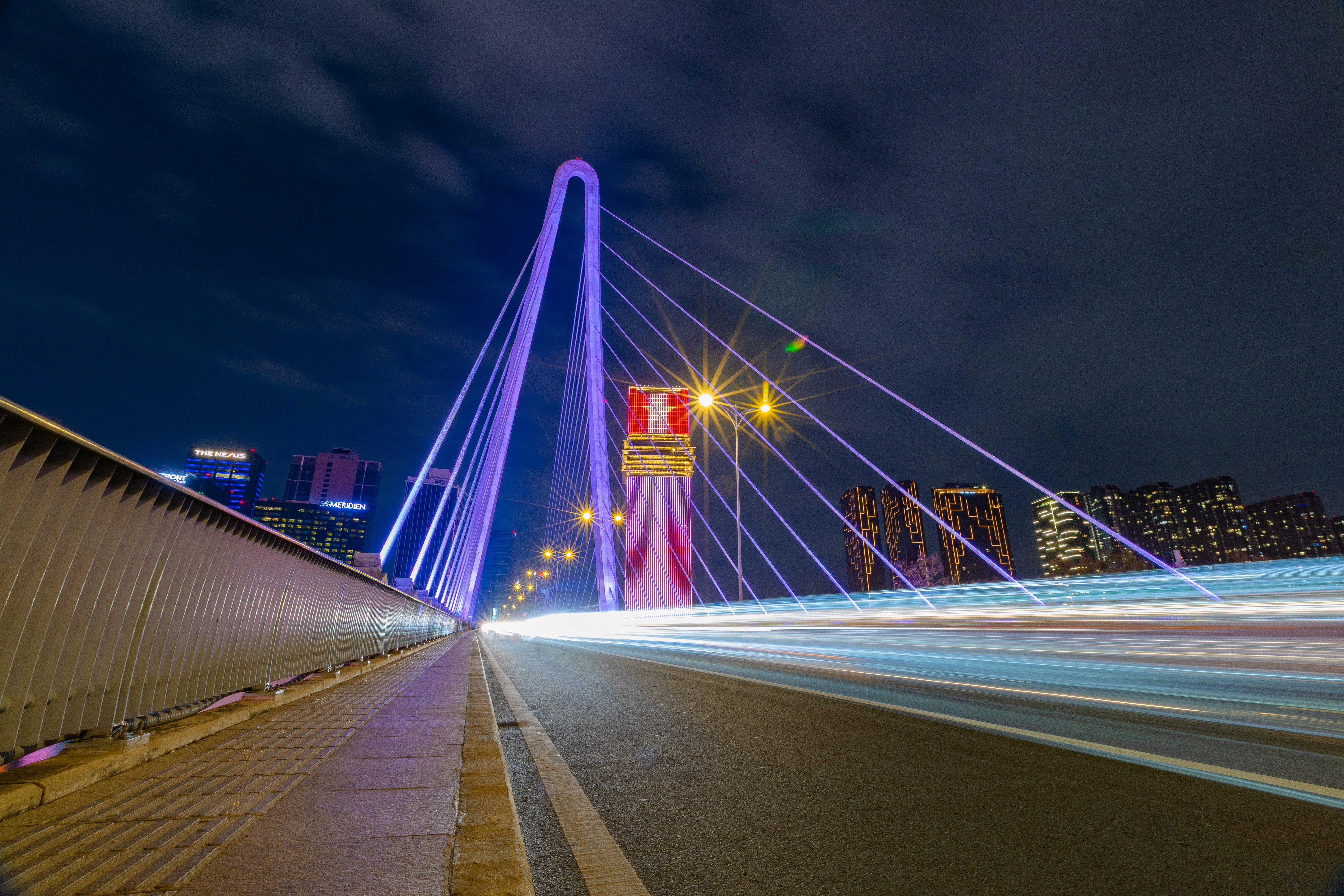 Crossing the Night Arc: A Neon-Highlighted Suspension Bridge