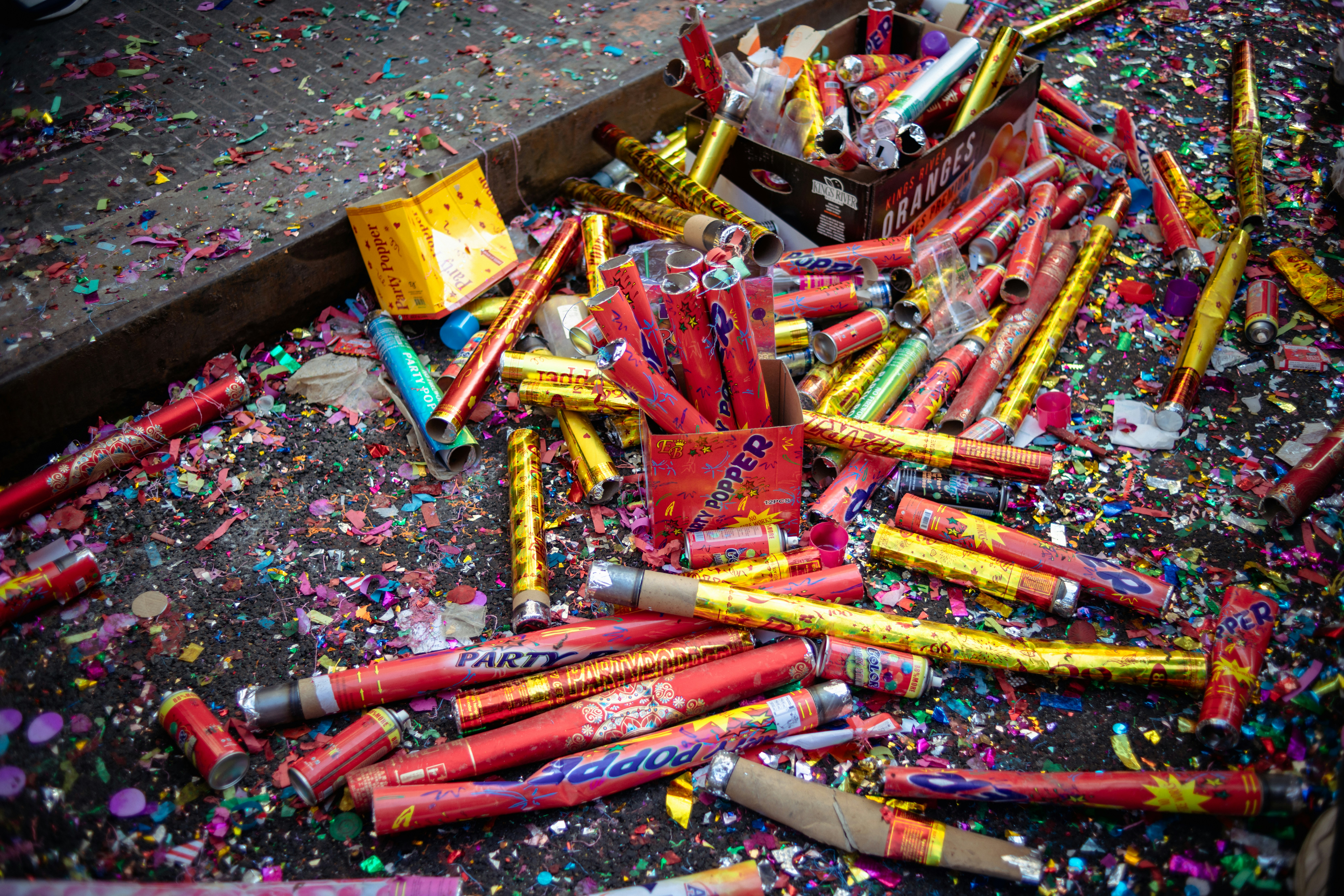 Fireworks debris and confetti scattered on the ground.