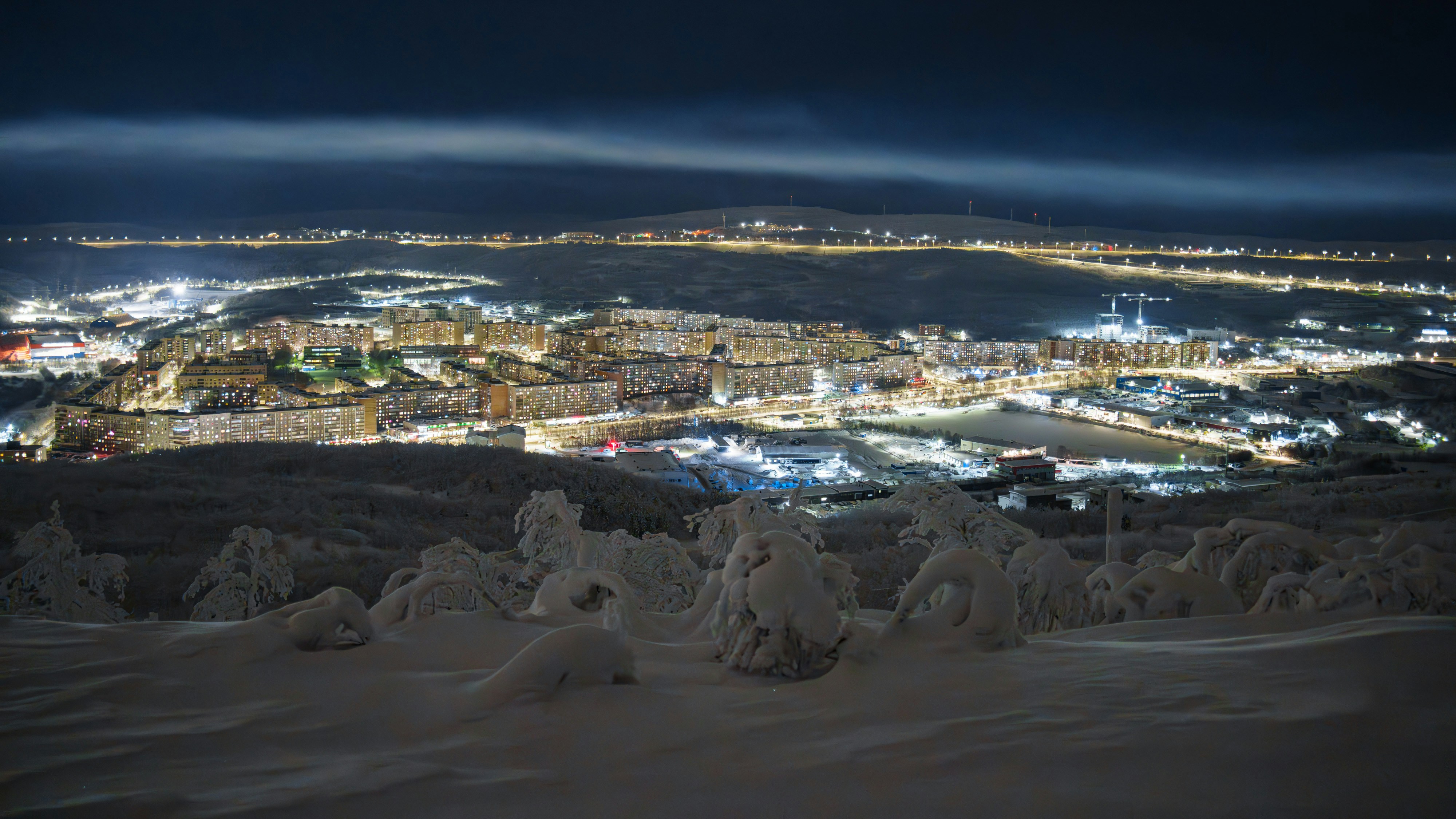 Moonlit Snow Coast Overlooking a Distant City