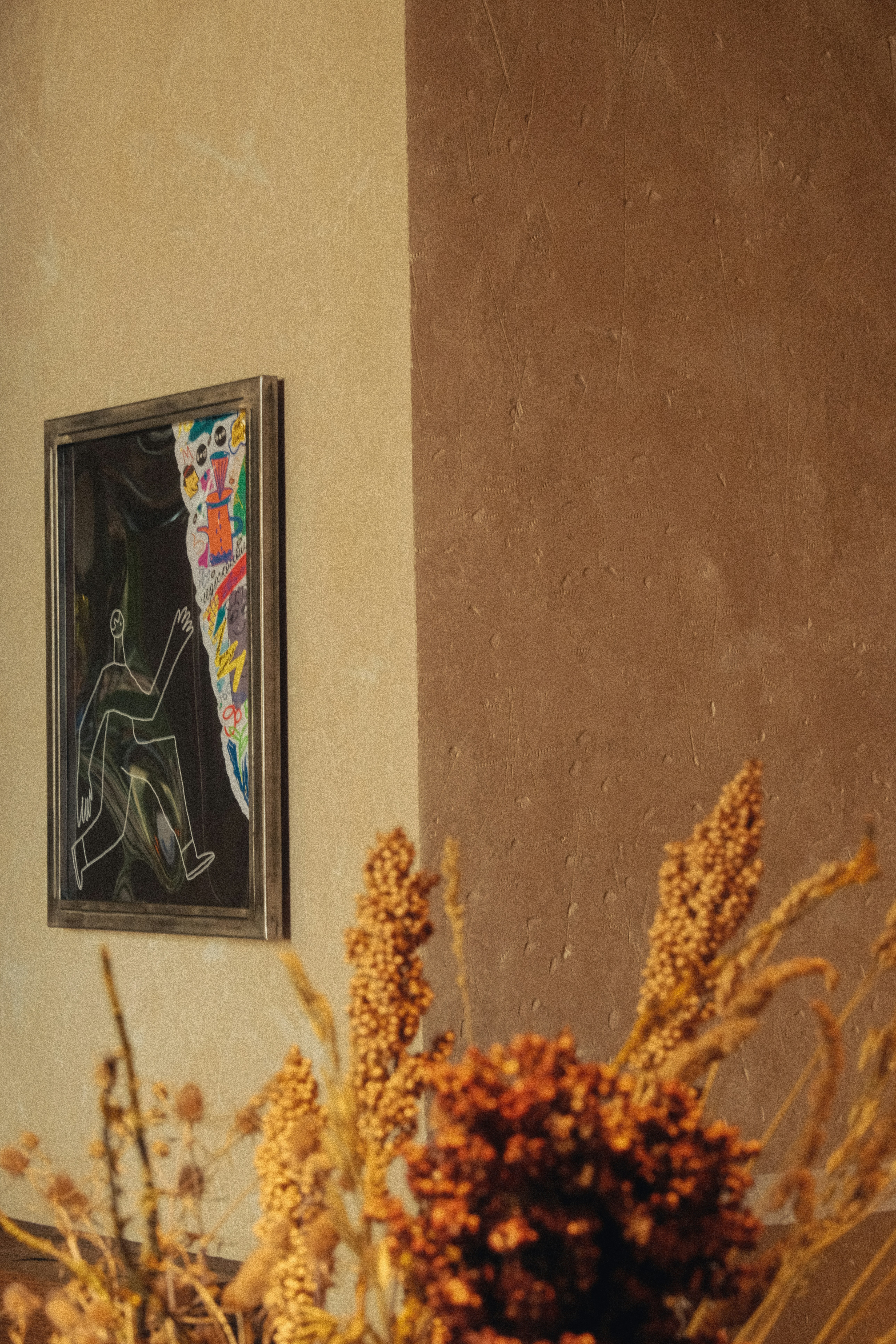 Muted Gallery: A framed chalk figure beside dried florals