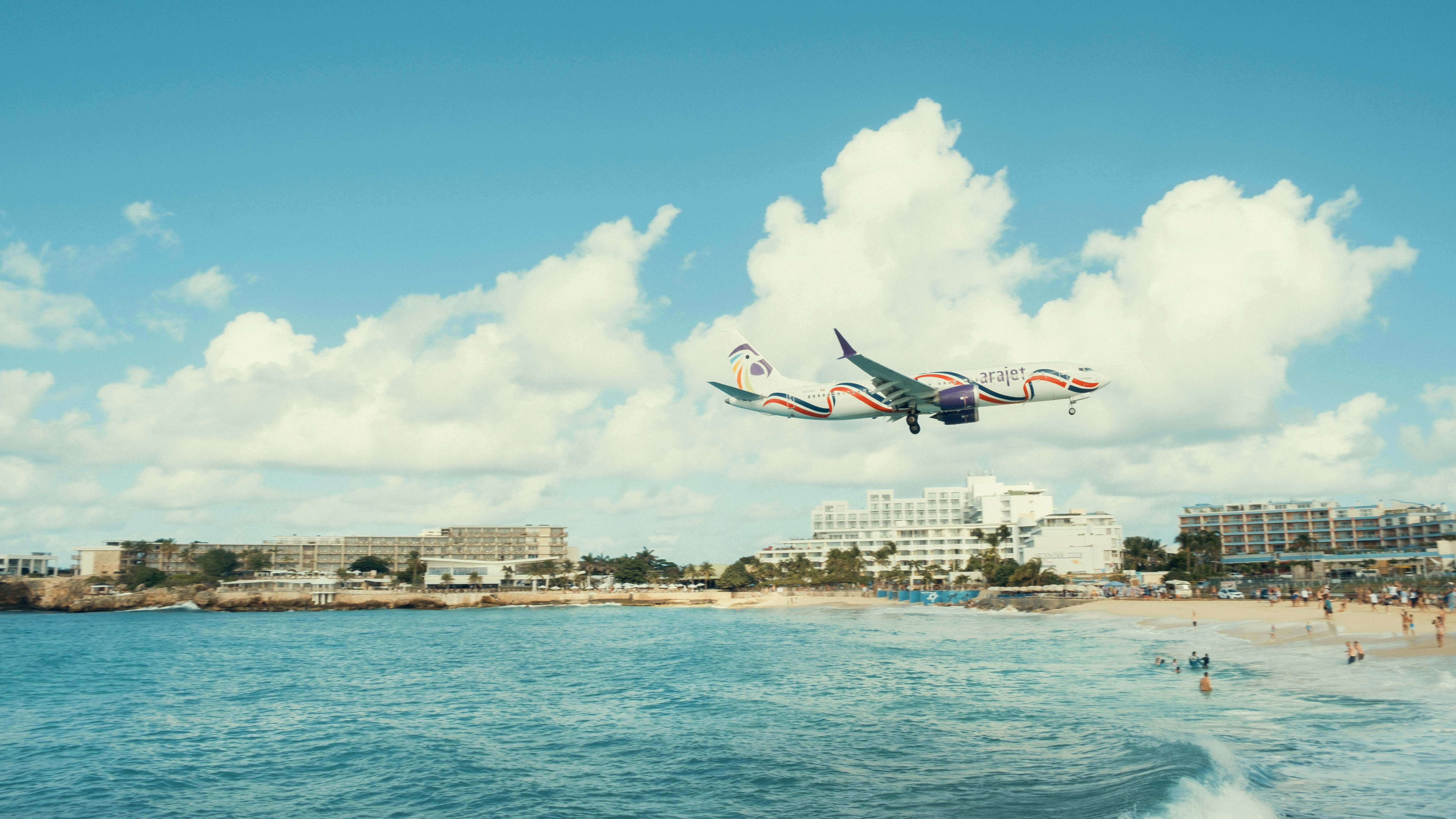 Aerial Runway: Seaplane Lift-Off Over a Sunny Beachfront