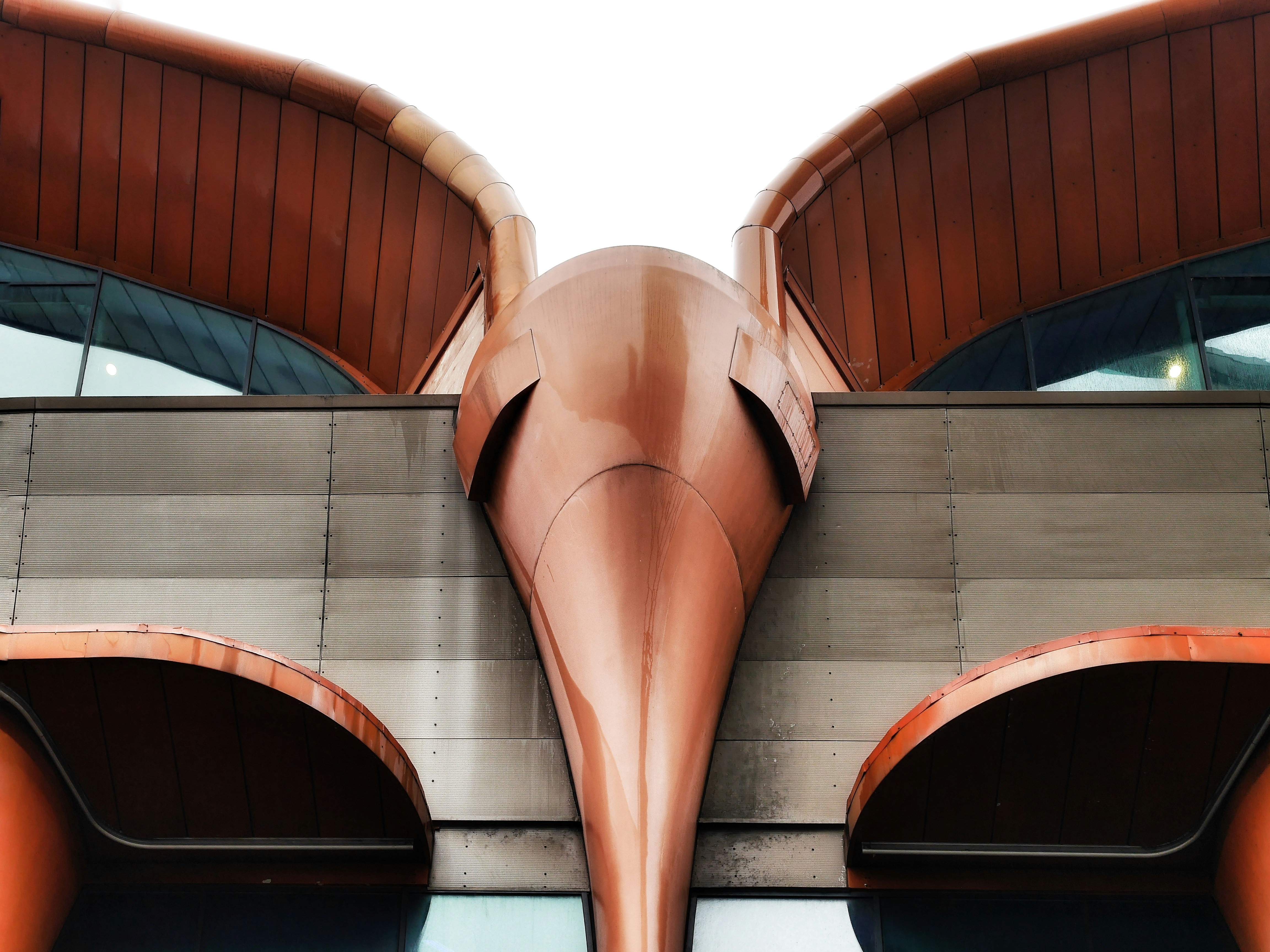 Central Rusted Spine: A Geometric Facade of Inferno-Orange Arches