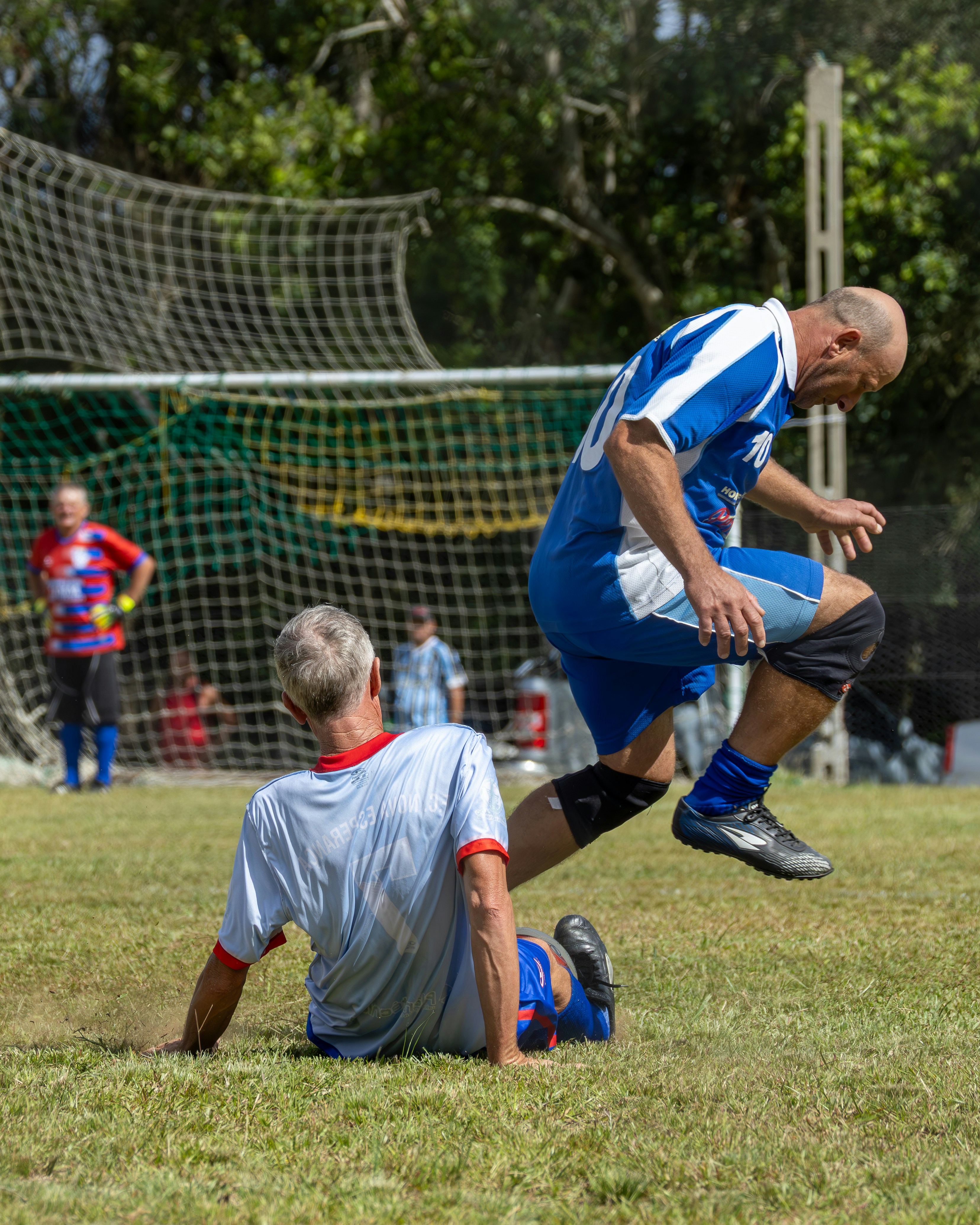 Men playing soccer on a grassy field