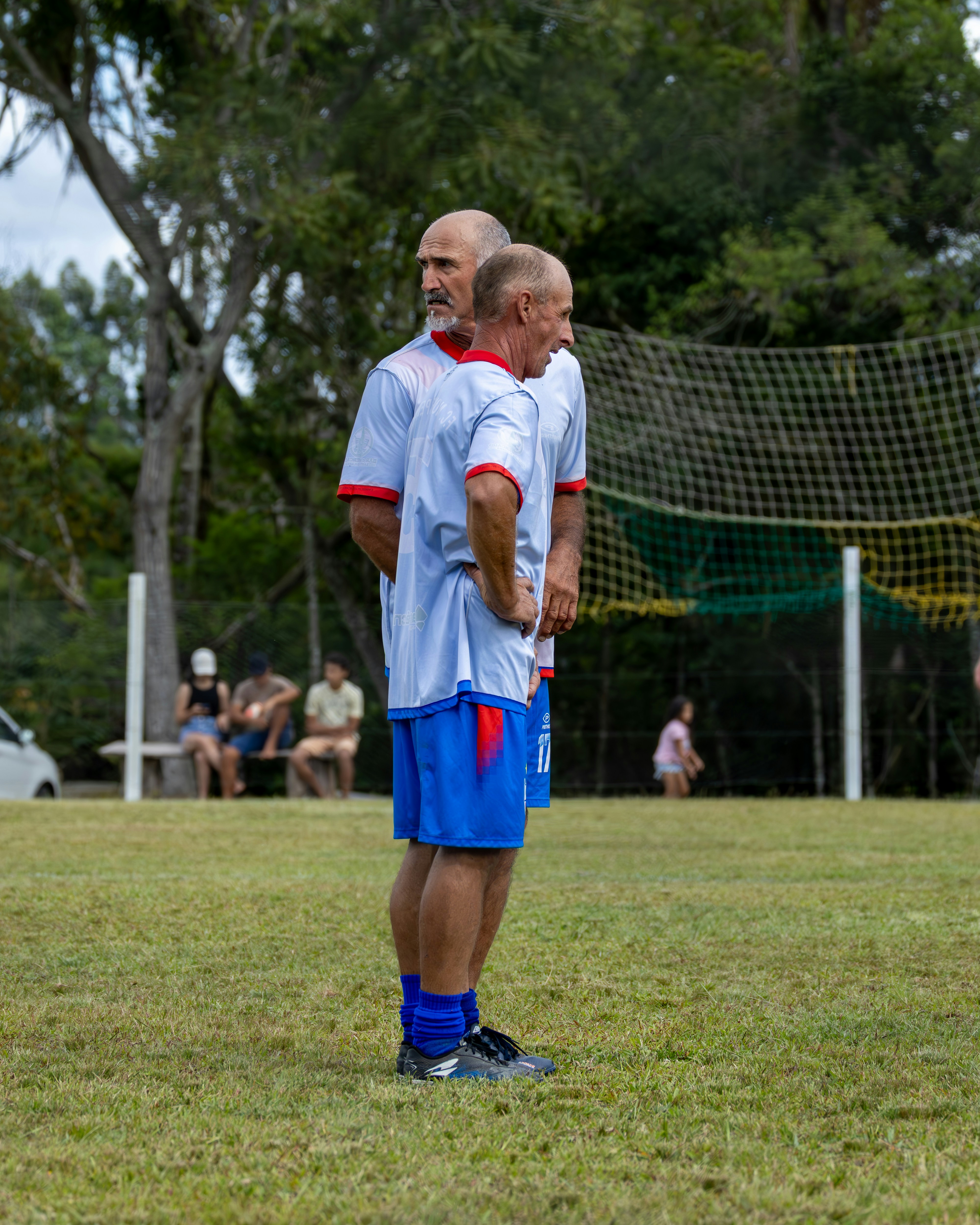 Two men in soccer uniforms on a field.