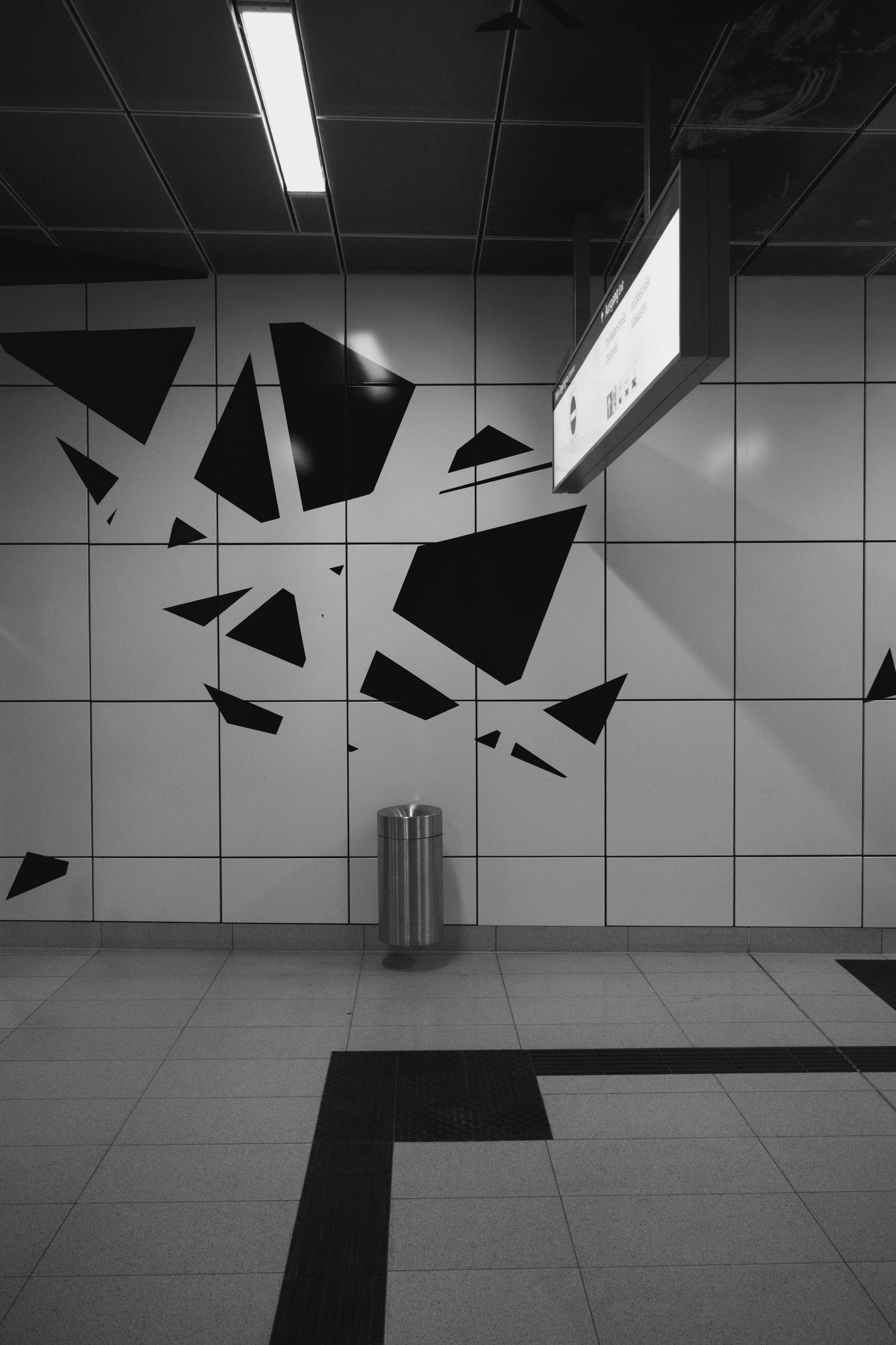 Monochrome Mosaic: Fragmented Wall in a Subwayscape