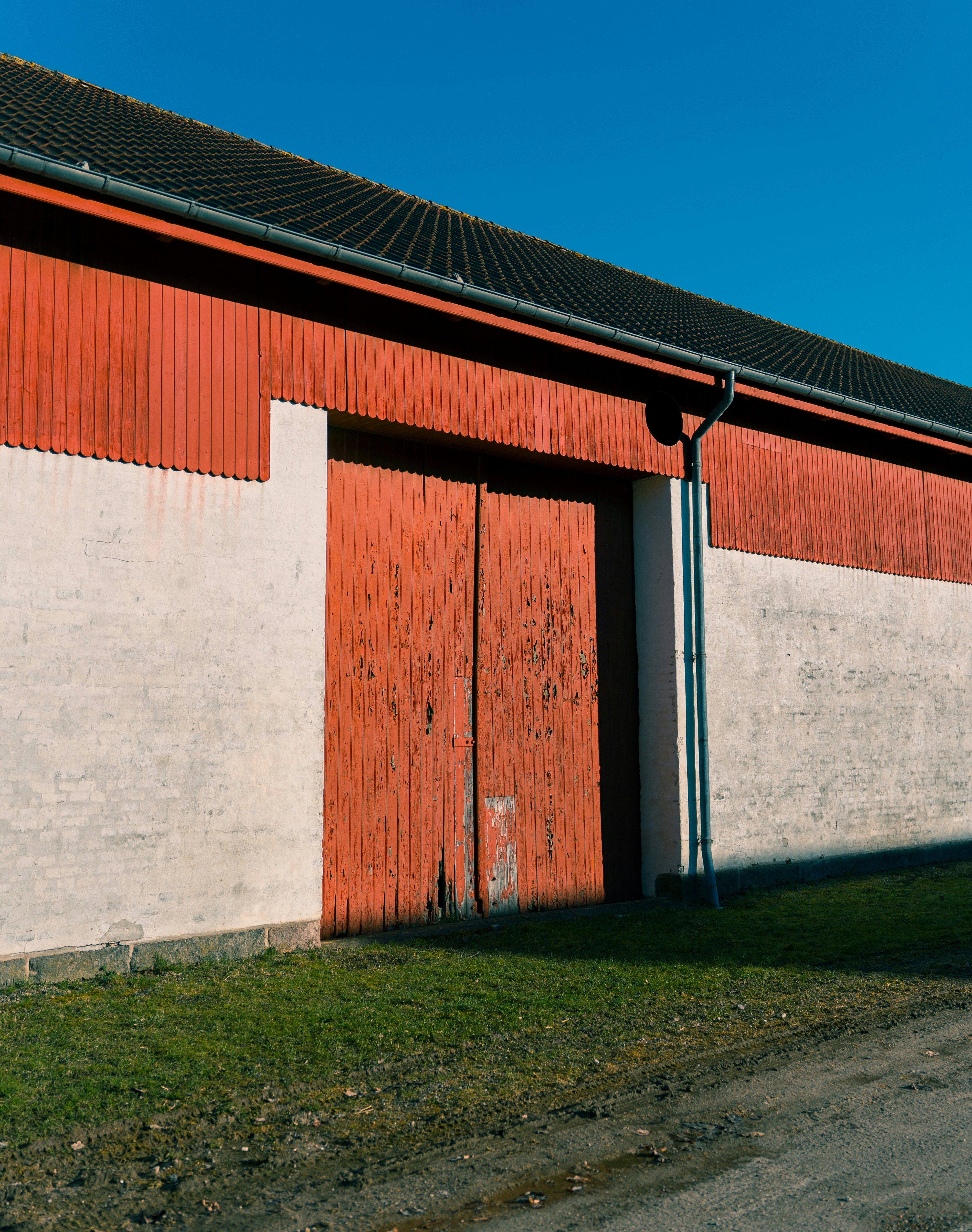 Red Barn Doors Under a Sharp Blue Sky