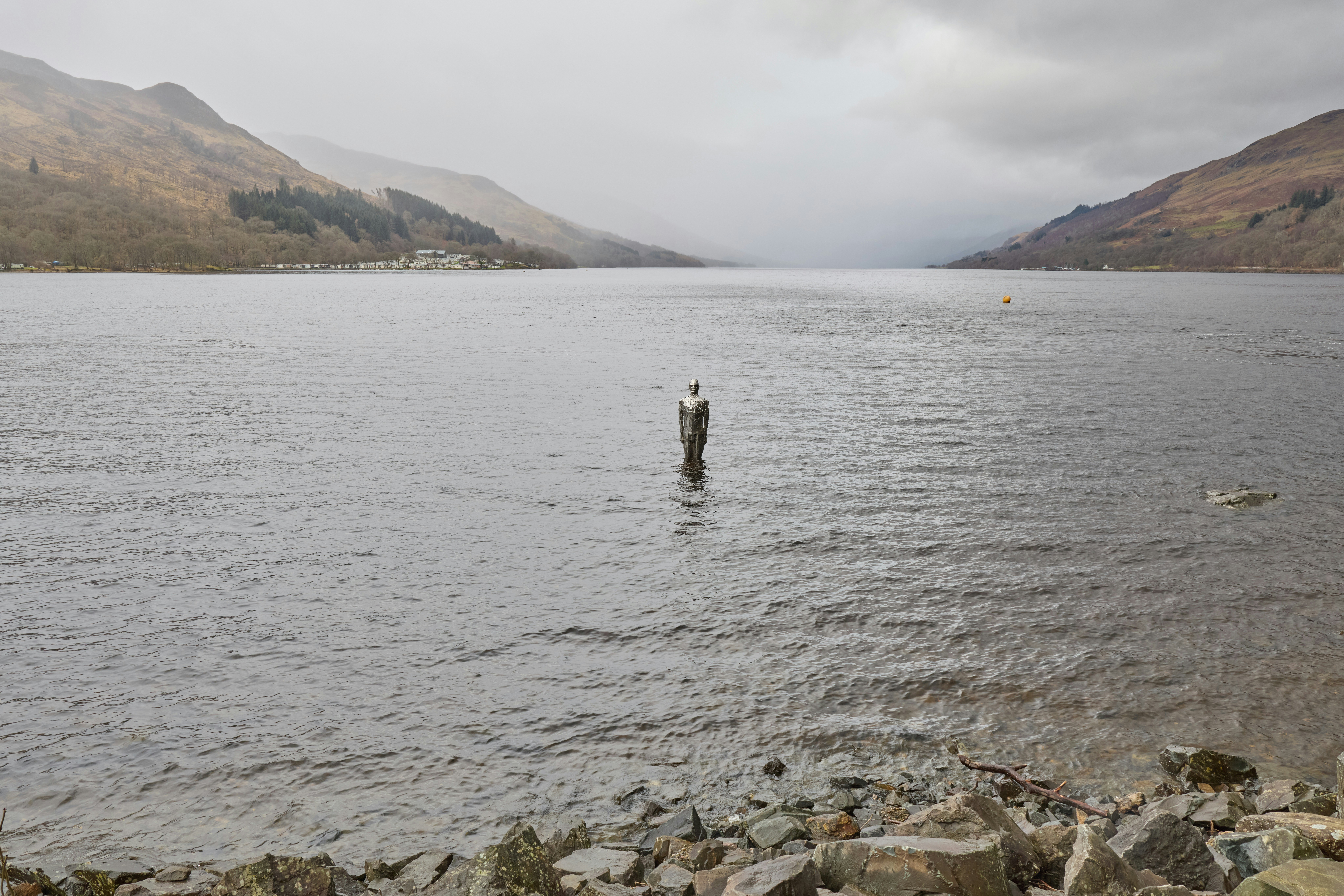 Solitary Angler in the Silent Fjord