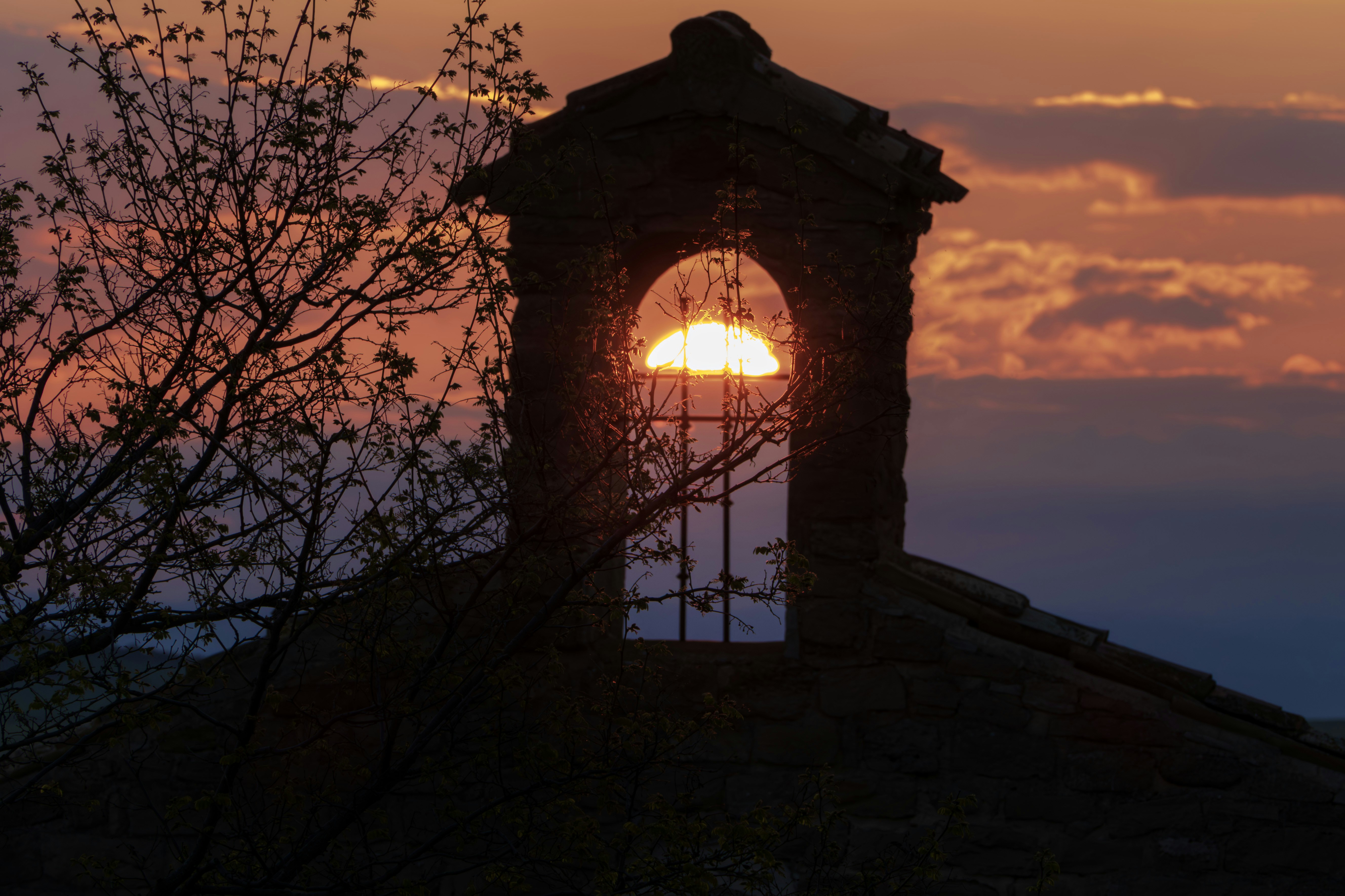 Sun-Halo Through a Stone Archway at Dusk