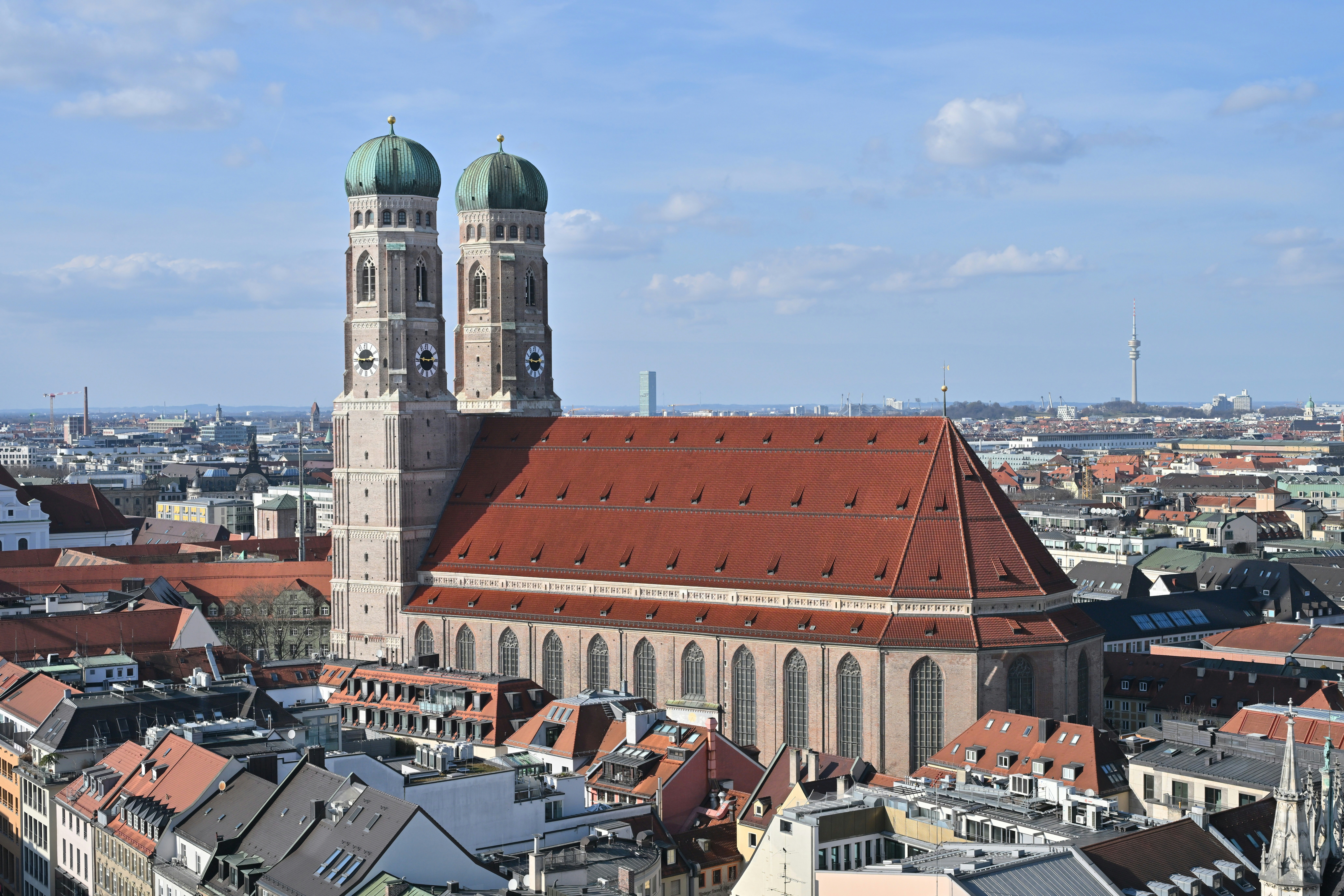 Twin-towered Basilica Over Munich-like Rooftops at Golden Hour