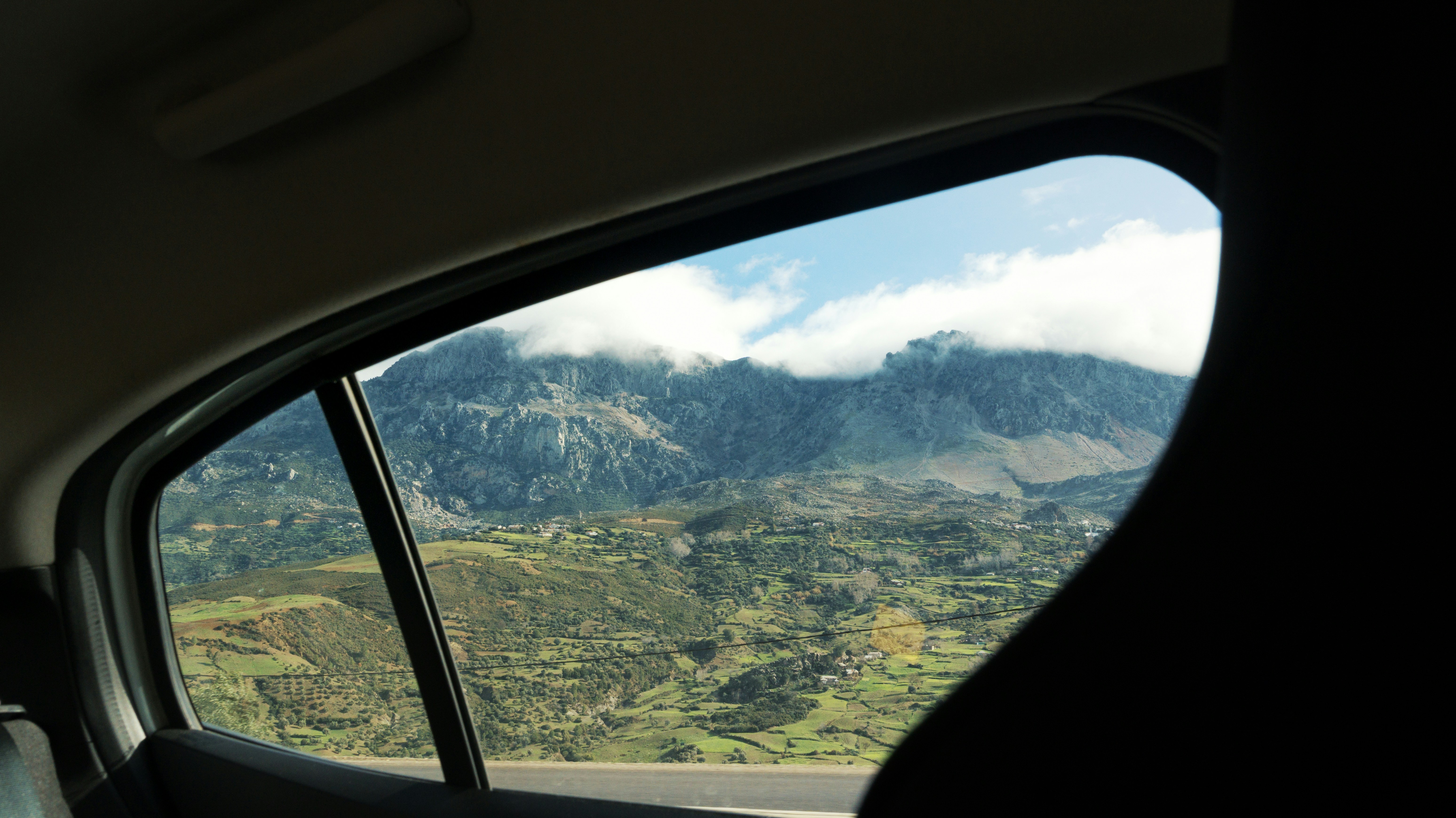 Window Seat Overlook: Terraced Valleys Beneath Shifting Clouds