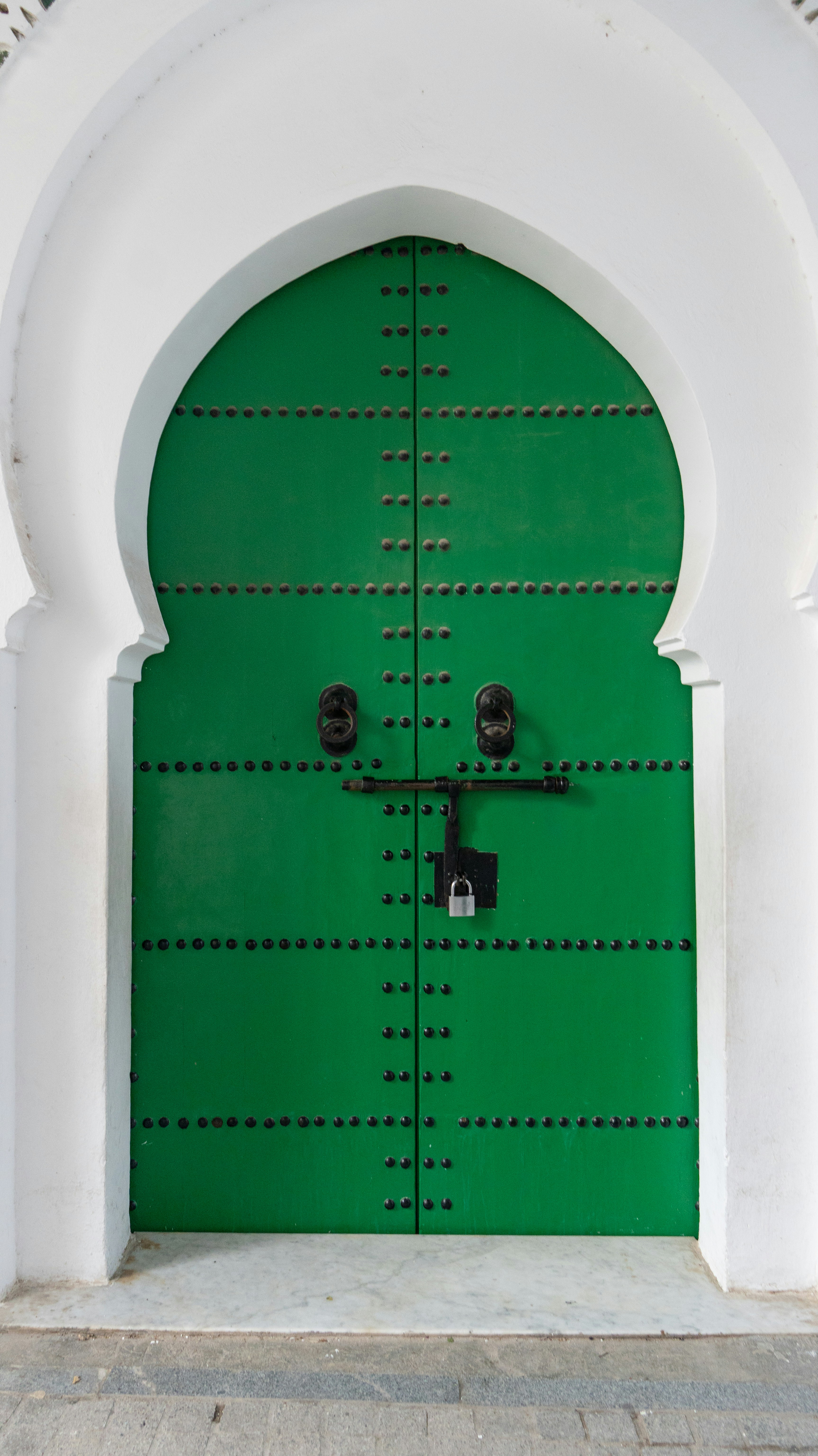 Green Archway Door: A Stubborn Portal Framed in White
