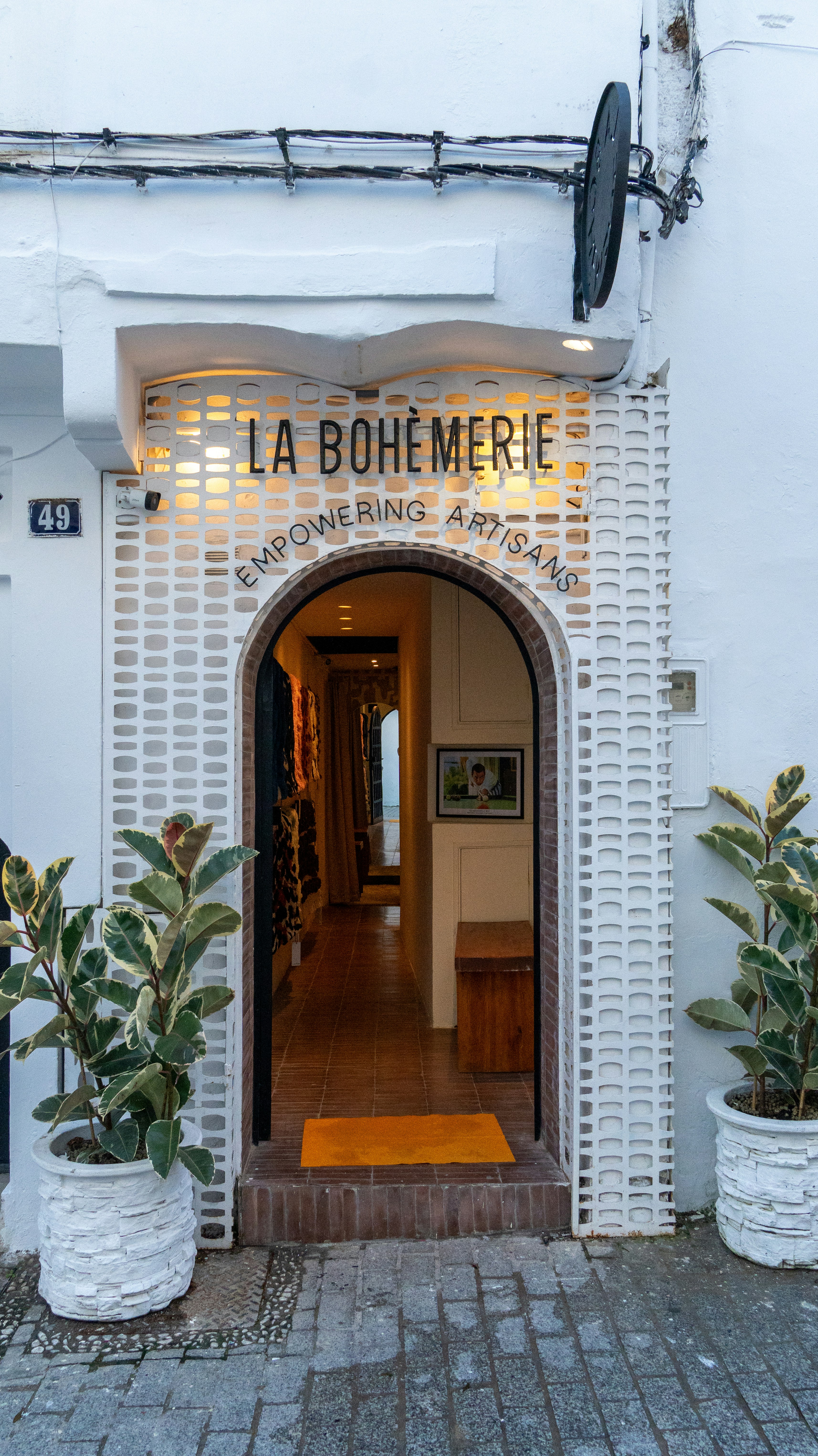 Storefront entrance with plants and "la boheme" sign.
