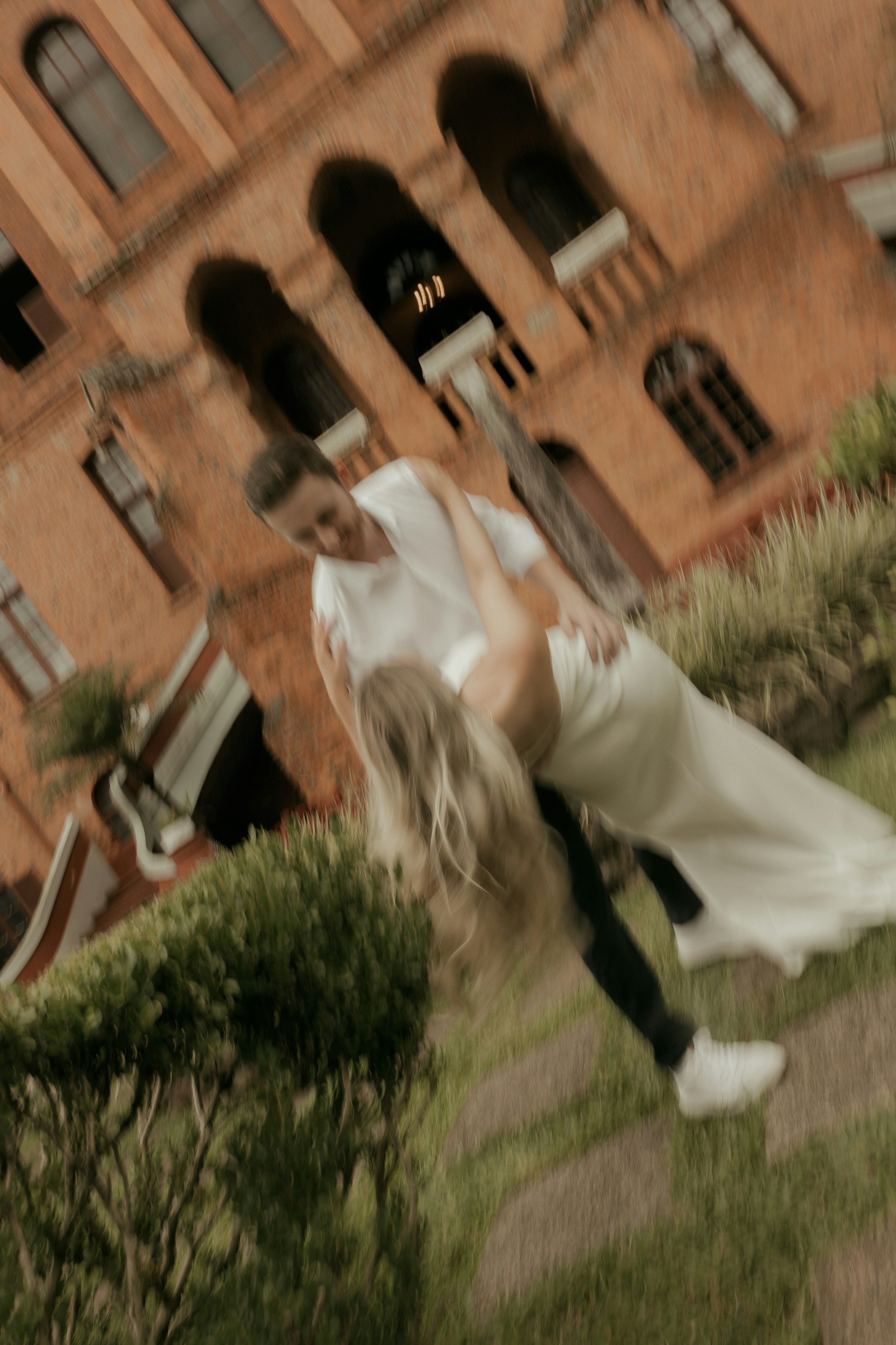 Dramatic Tilt: A Daring Dance Between Bride and Groom in Motion