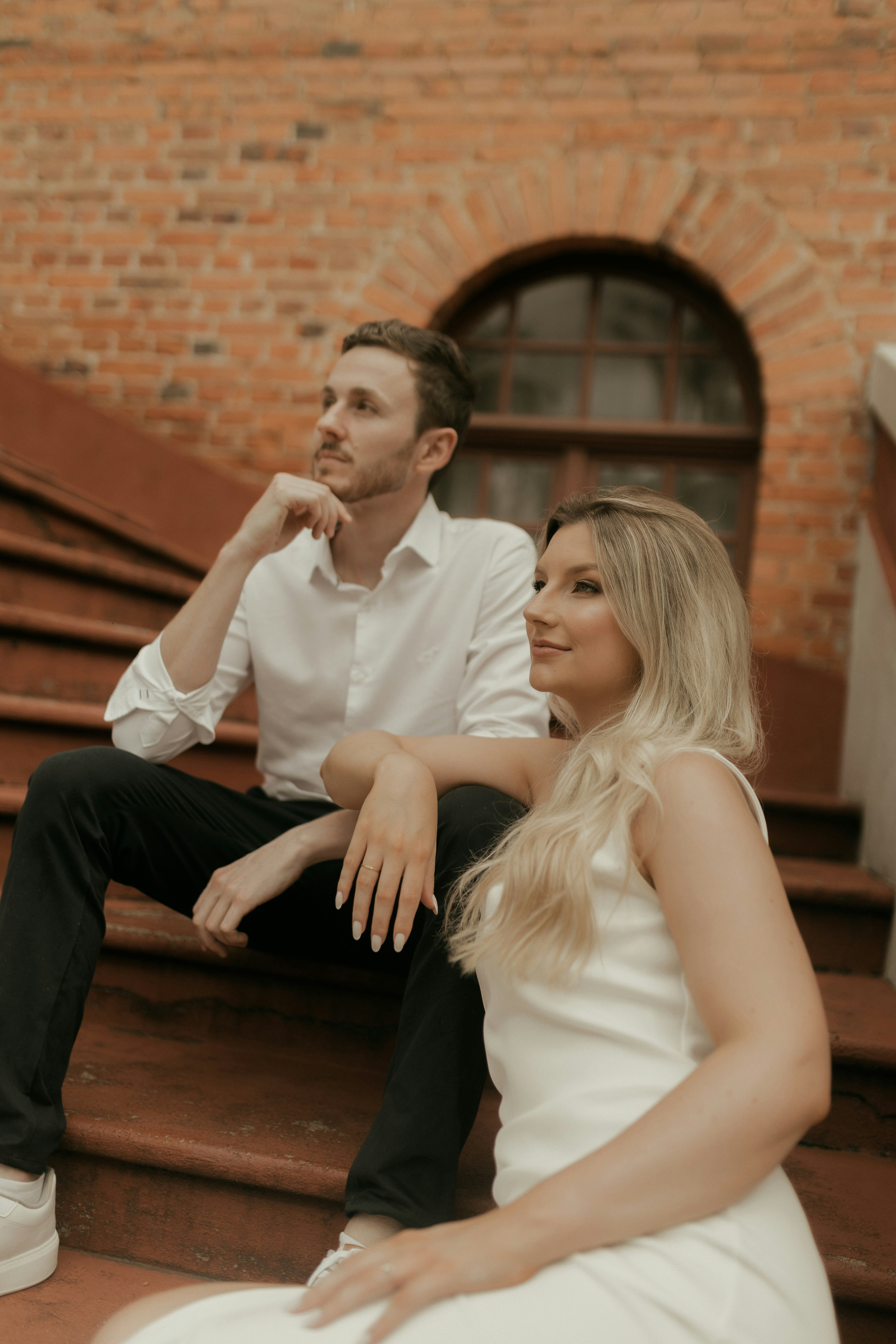 Couple on brick steps: quiet contemplation in warm light