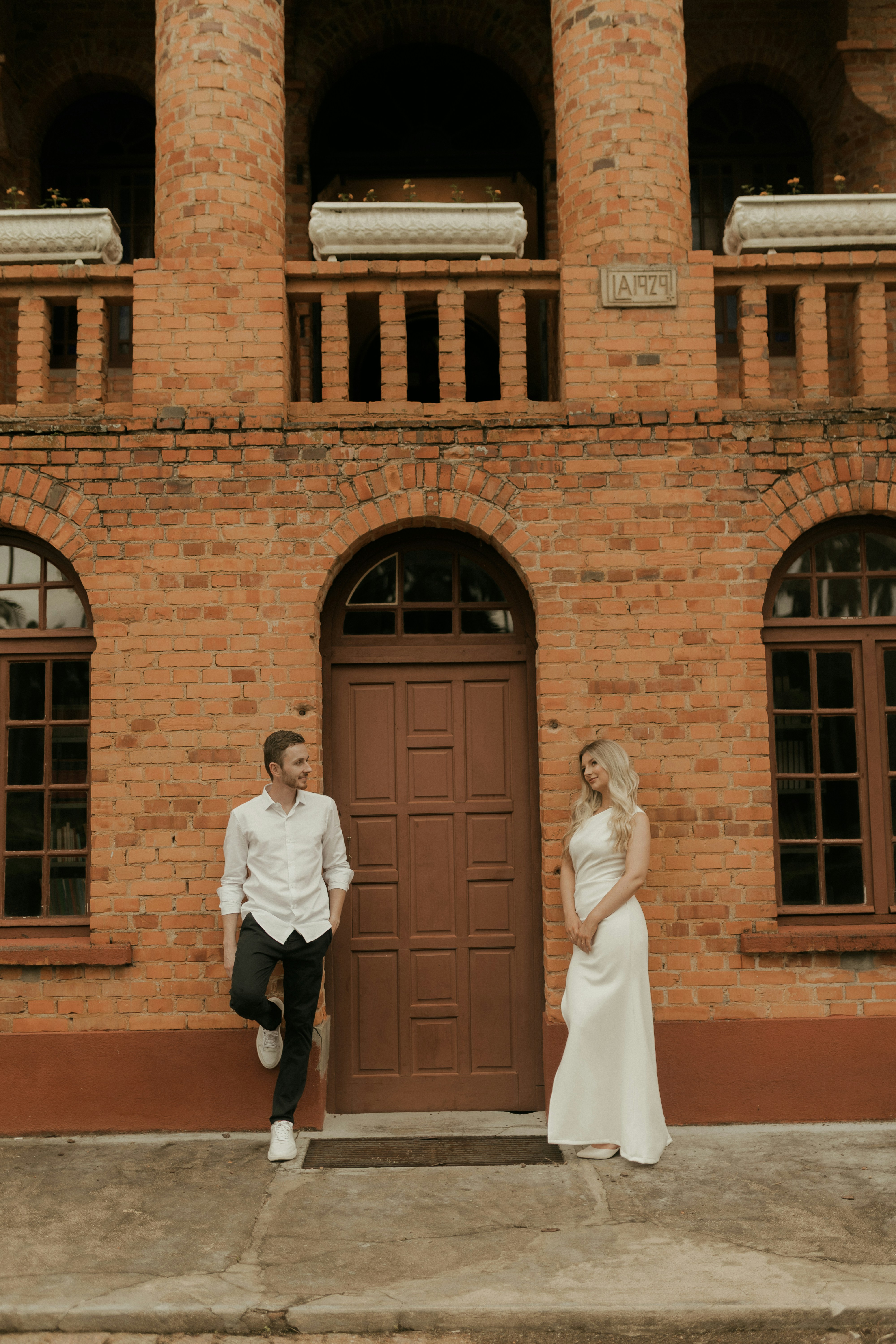 Brick Facade Duo: A Quiet Moment by the Arched Door